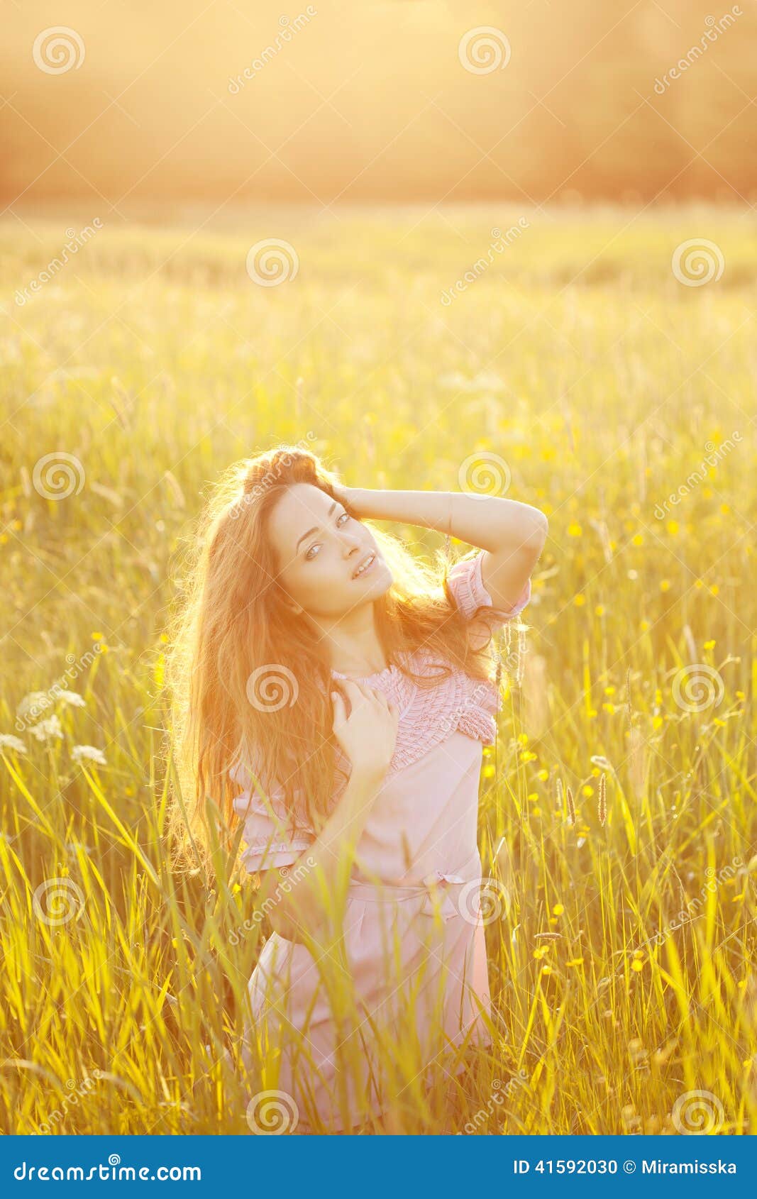 Smiling Woman in a Field at Sunset Stock Photo - Image of flower ...