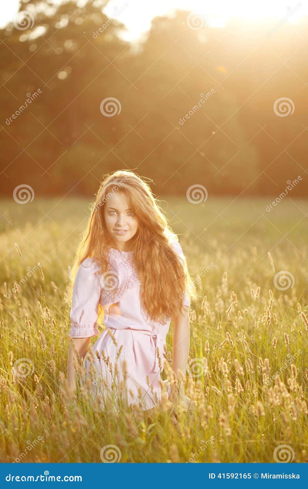 Smiling Woman in a Field at Sunset Stock Image - Image of model, light ...
