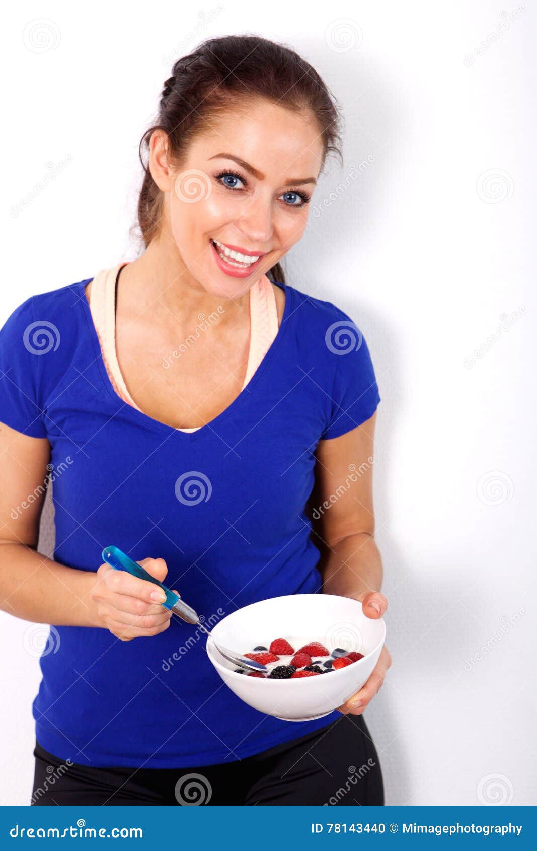 Smiling Woman Holding Bowl Of Healthy Food Against White Background