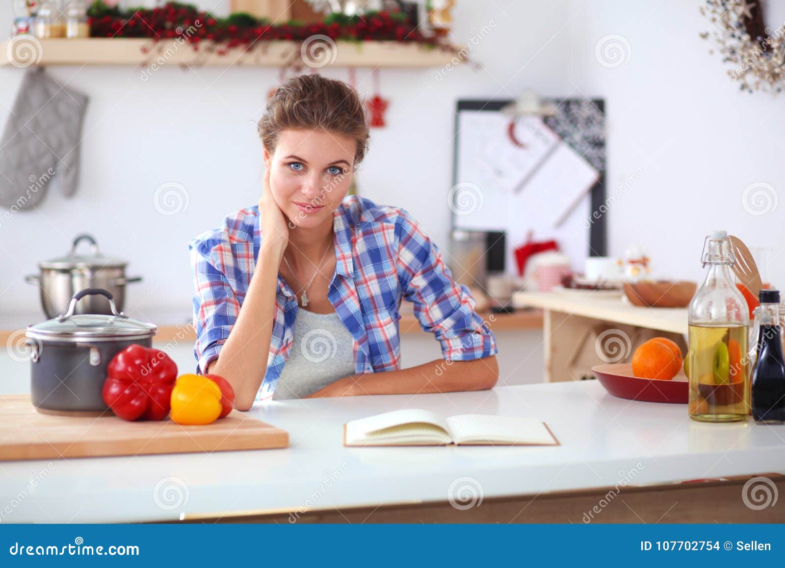 Smiling Woman Holding Her Cellphone in the Kitchen. Smiling Woman ... Smiling Woman Holding Her Cellphone in the Kitchen. Smiling Woman ...