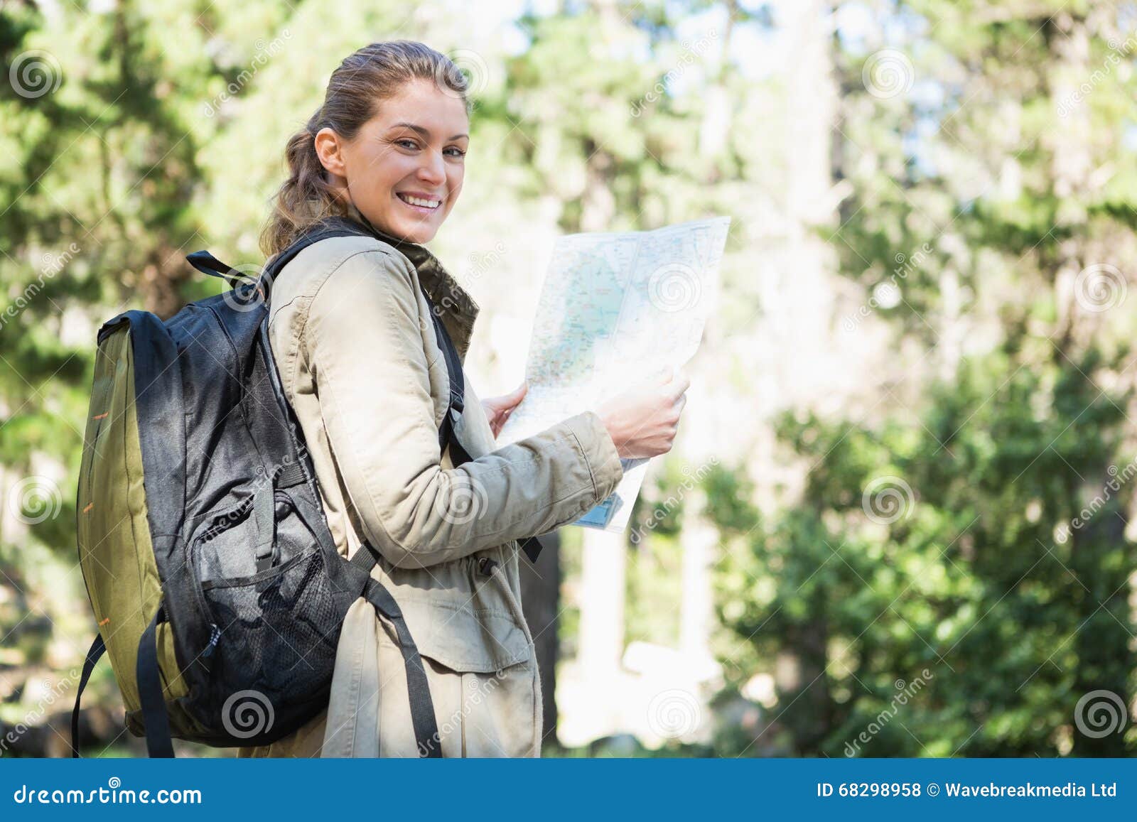 Smiling woman holding map stock photo. Image of adventurer - 68298958