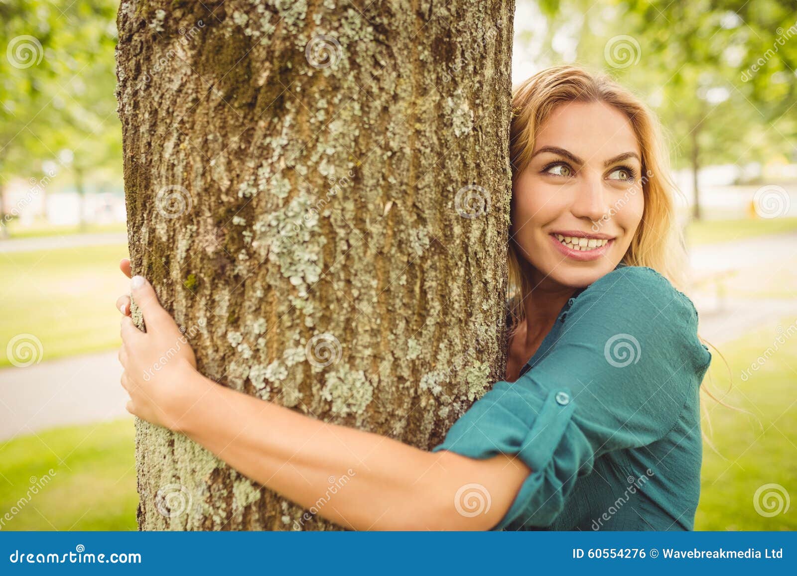 Smiling woman hugging tree stock photo. Image of leisure - 60554276