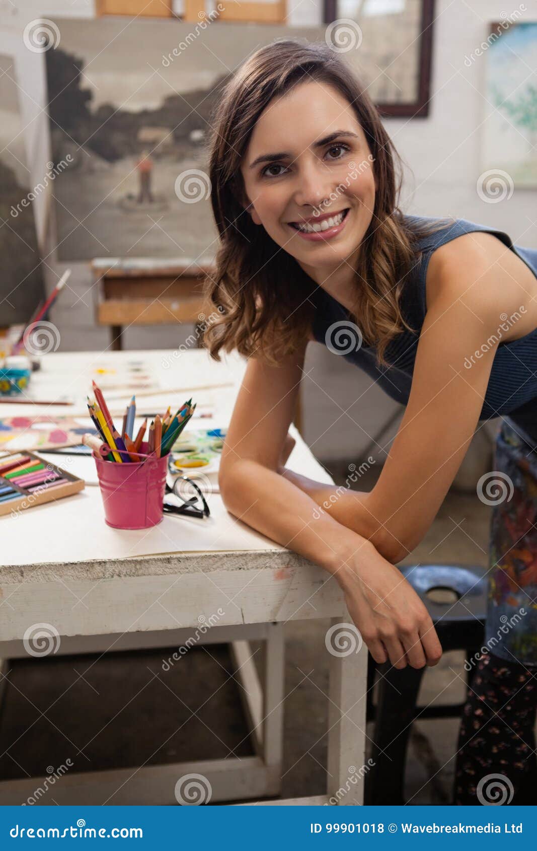 Smiling Woman Leaning at Table in Drawing Class Stock Photo - Image of ...