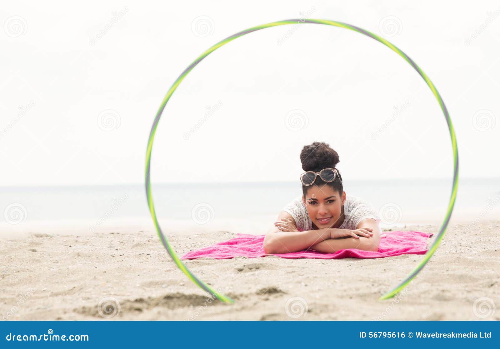 Smiling Woman Looking at Camera through Hula Hoop Stock Photo - Image ...