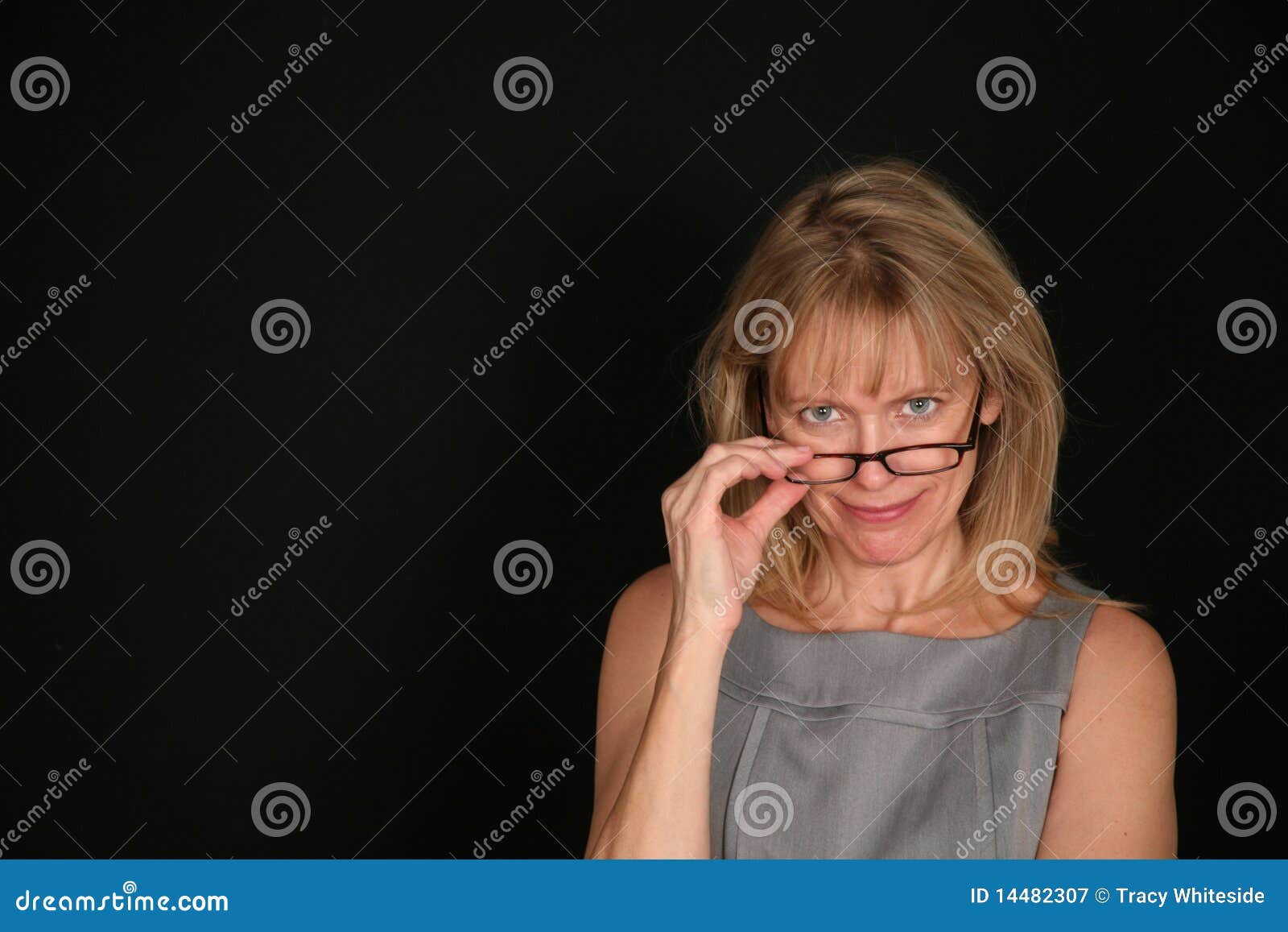 Smiling Woman Looking Over Glasses Stock Image - Image of older ...