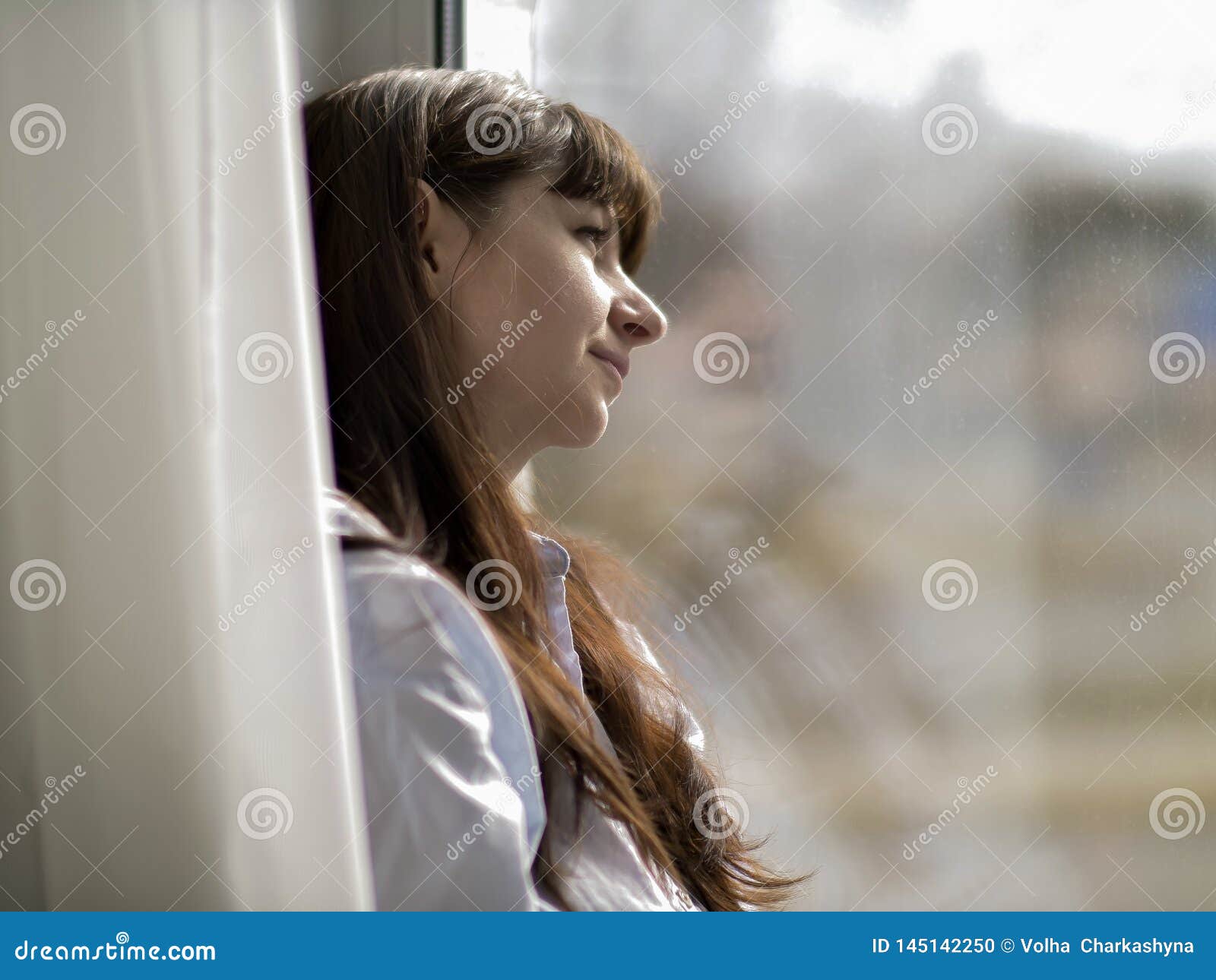 Young Smiling Woman Looks Out the Window Stock Photo - Image of happy ...