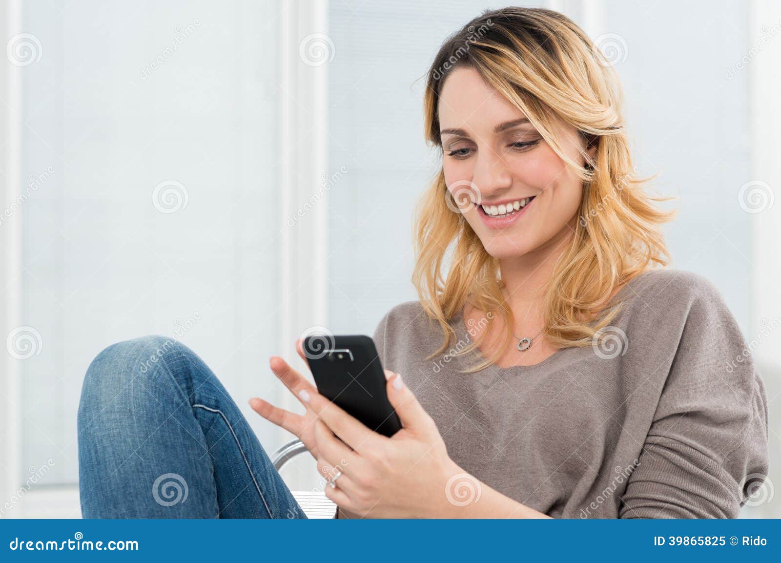 Smiling Woman Playing with Cellphone Stock Image - Image of portable ...