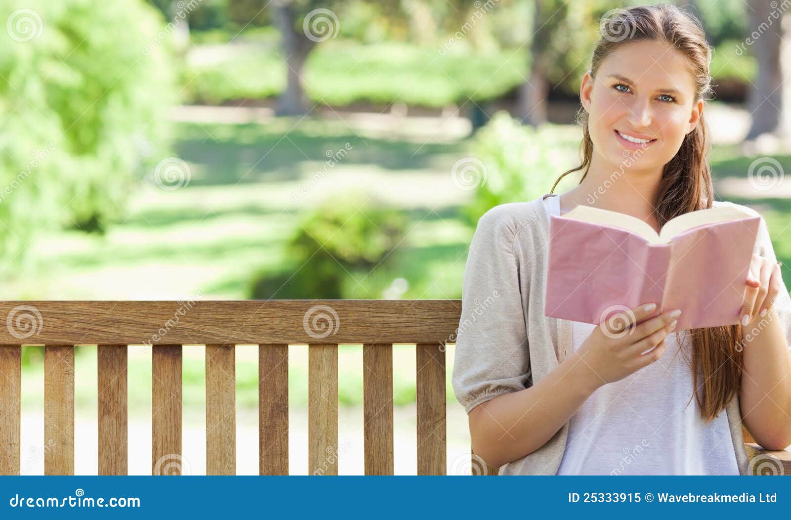 Smiling Woman Reading a Book on a Park Bench Stock Image - Image of ...