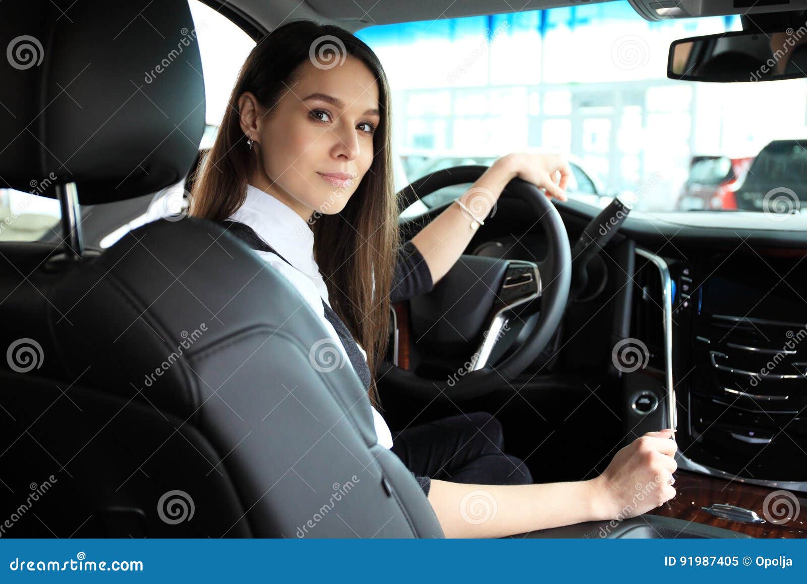 Smiling Woman Sitting in a Car and Looking Back. Toned Image Stock ...