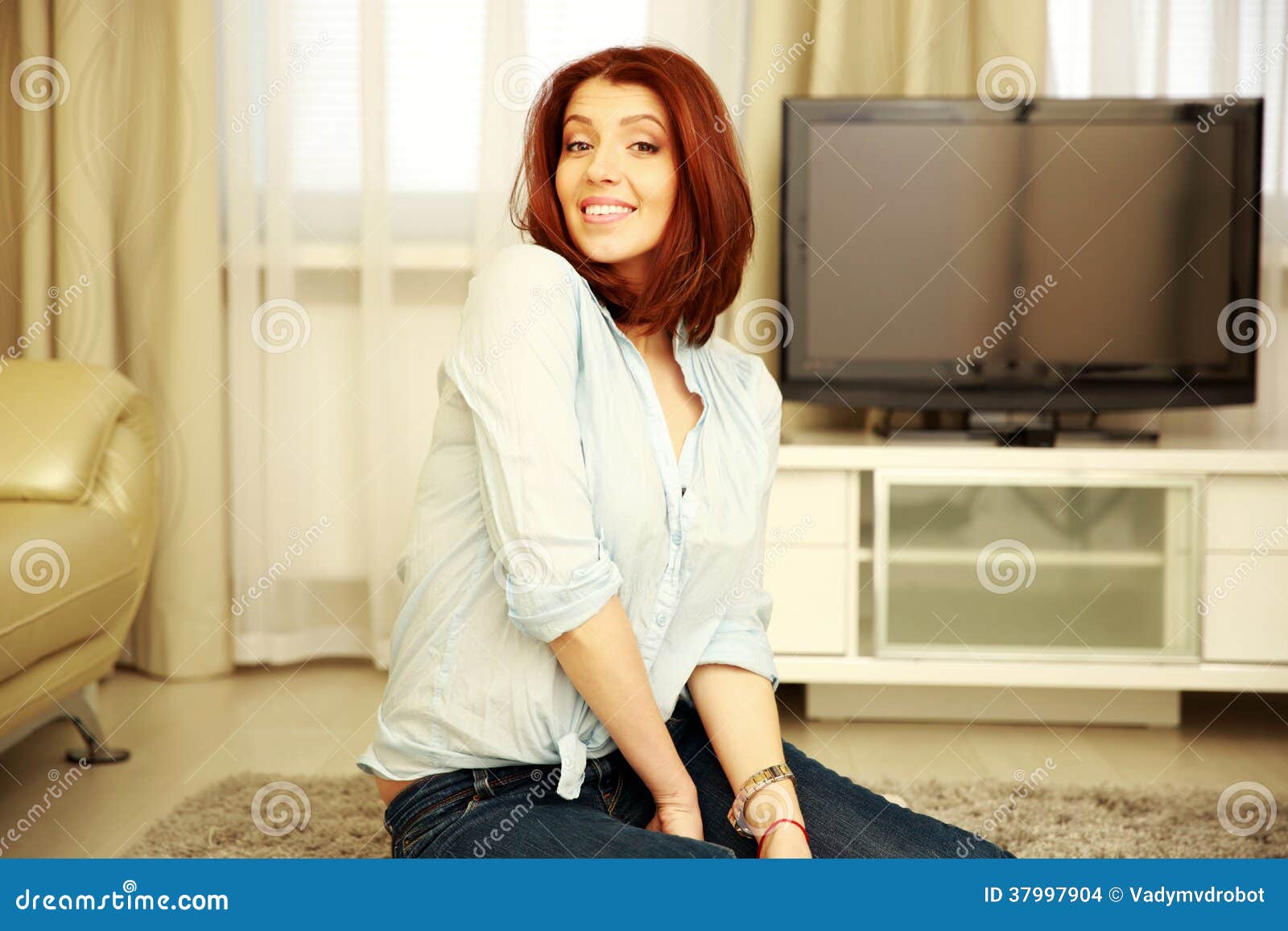 Smiling Woman Sitting on the Carpet Stock Photo - Image of pretty ...