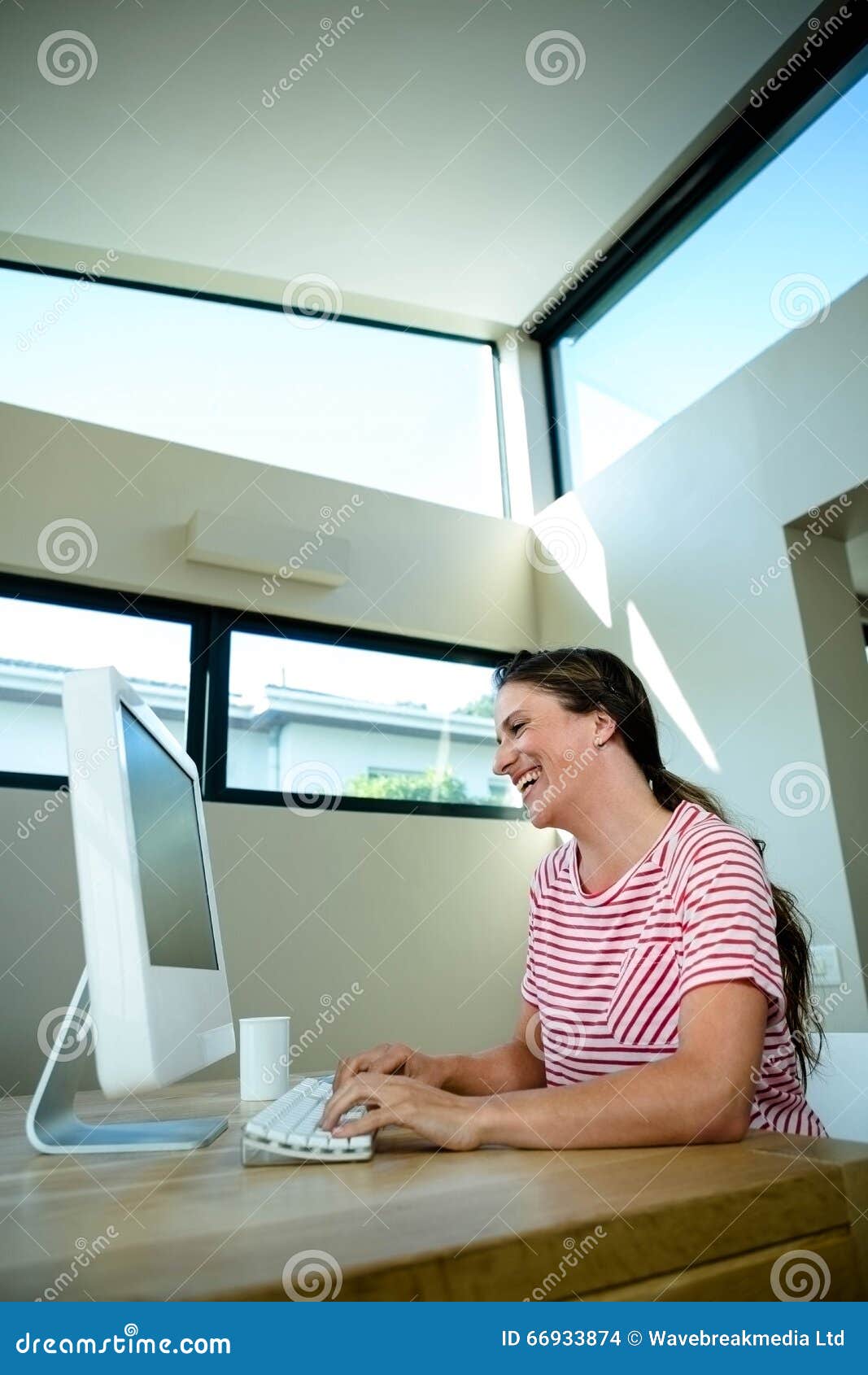 Smiling Woman Sitting at Her Computer Laughing Stock Photo - Image of ...