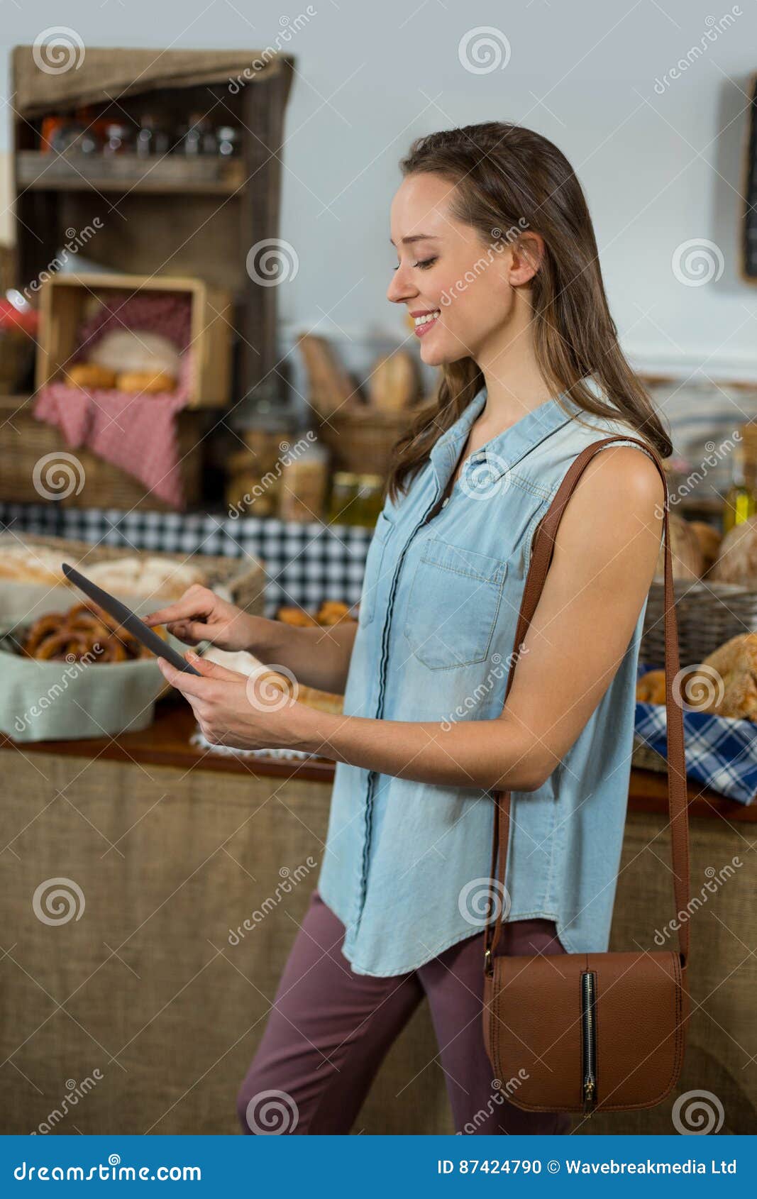 Smiling Woman Standing at Counter Using Digital Tablet Stock Photo ...