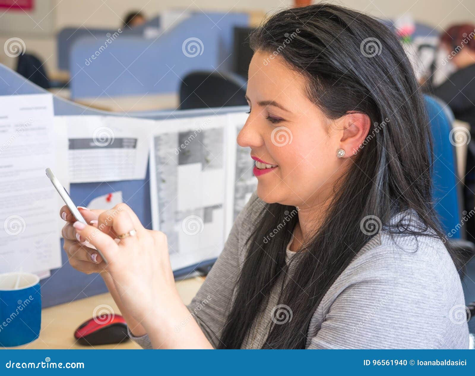 Smiling Woman Texting on Mobile Phone at Work Stock Photo - Image of ...