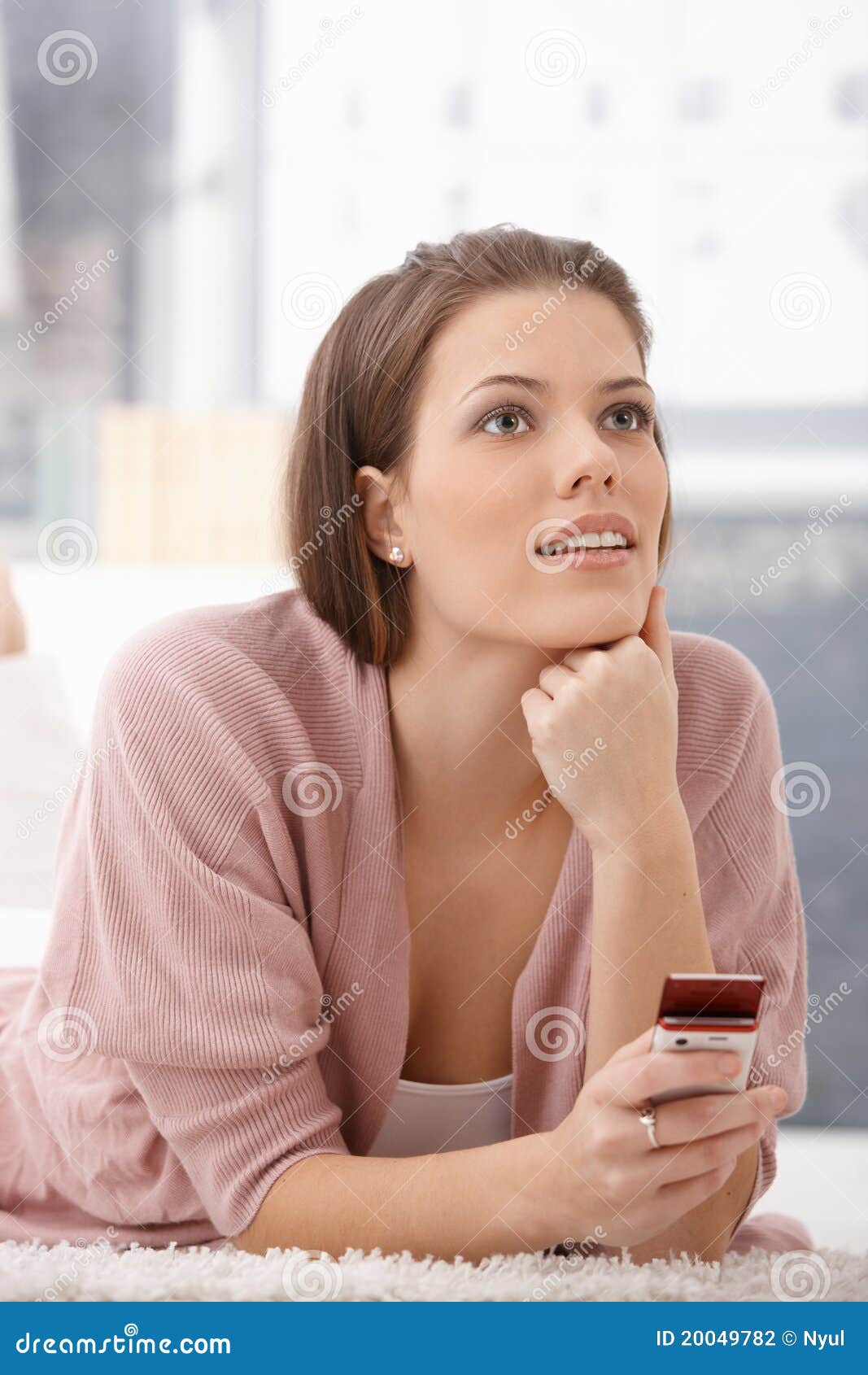 Smiling Woman Thinking with Phone in Hand Stock Photo - Image of ...