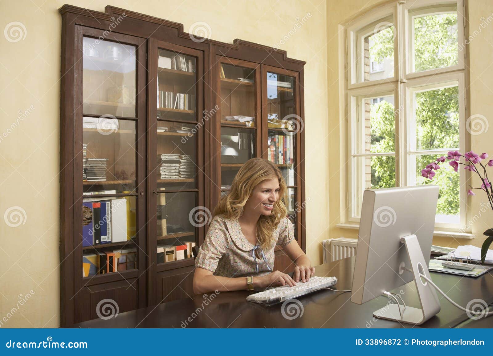 Smiling Woman Using Computer in Study Room Stock Photo - Image of ...