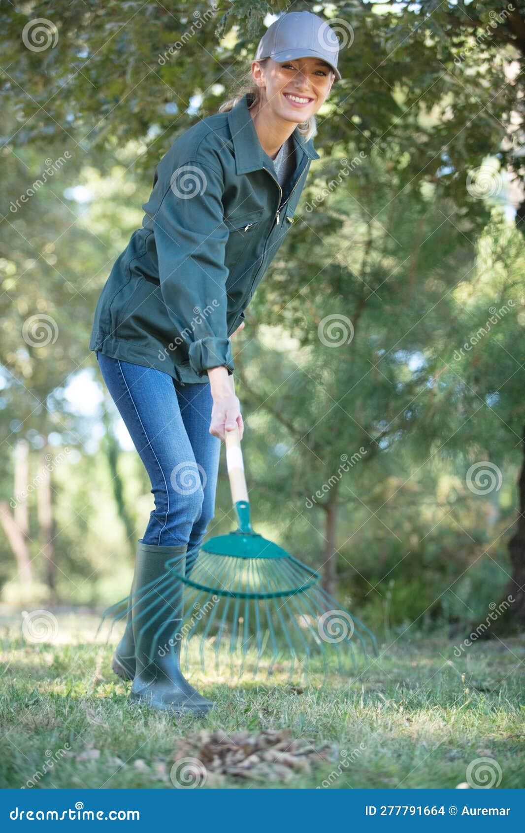Smiling Woman Using Garden Rake Stock Photo - Image of autumn, person ...