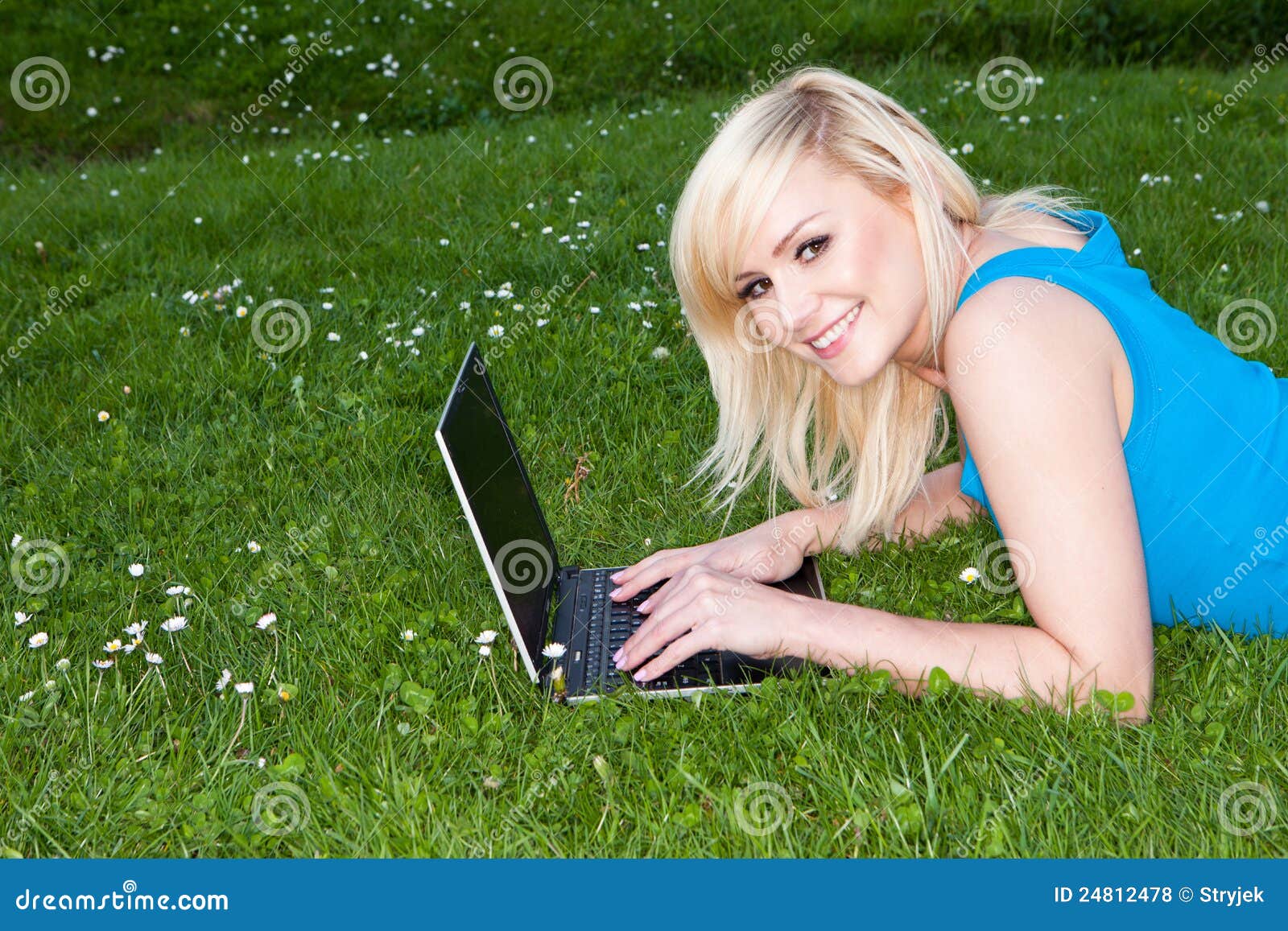Smiling Woman Using Her Laptop on the Grass Stock Photo - Image of ...