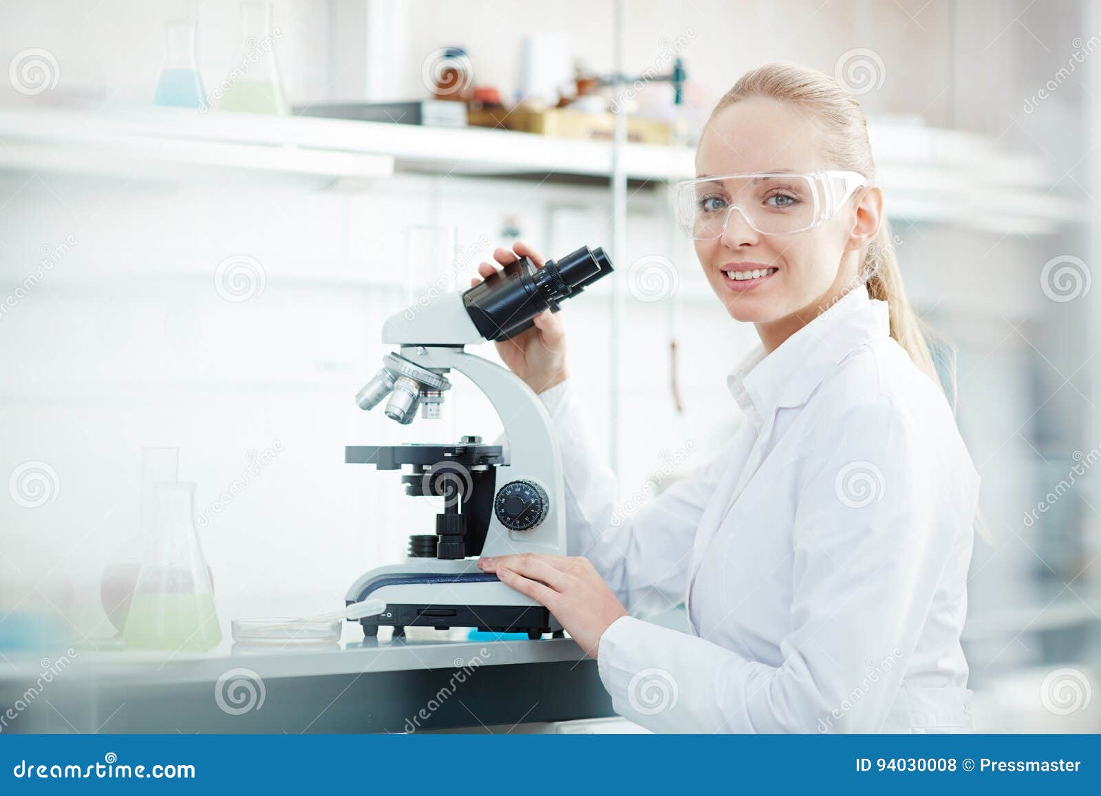 Smiling Woman Using Microscope in Laboratory Stock Photo - Image of ...