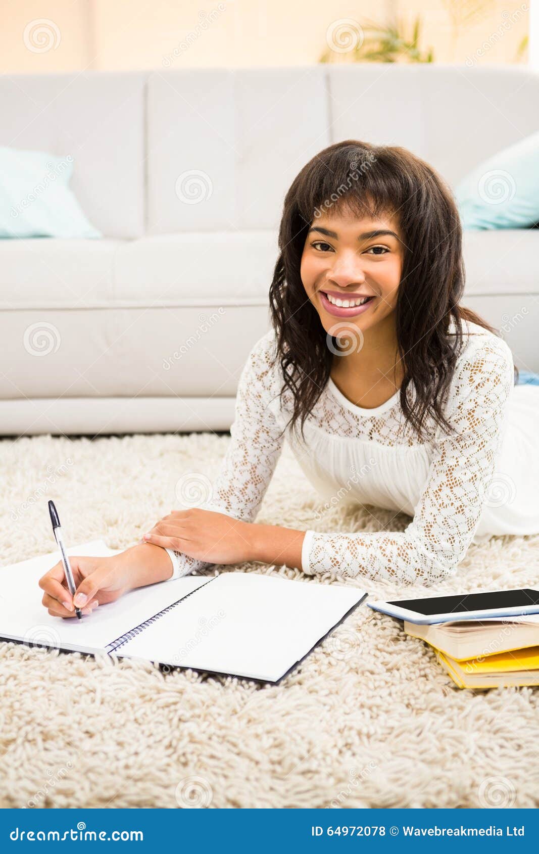 Smiling Woman Writing Notes while Looking the Camera Stock Photo ...