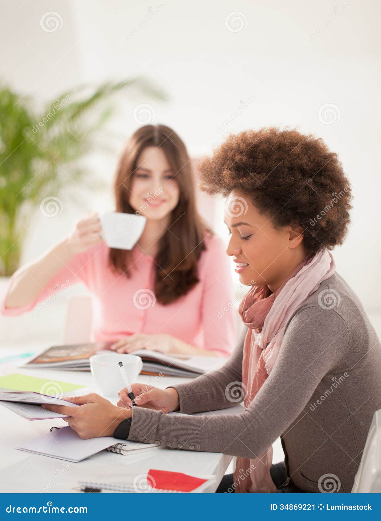 Smiling Women Studying Together Stock Image - Image of sitting, people ...