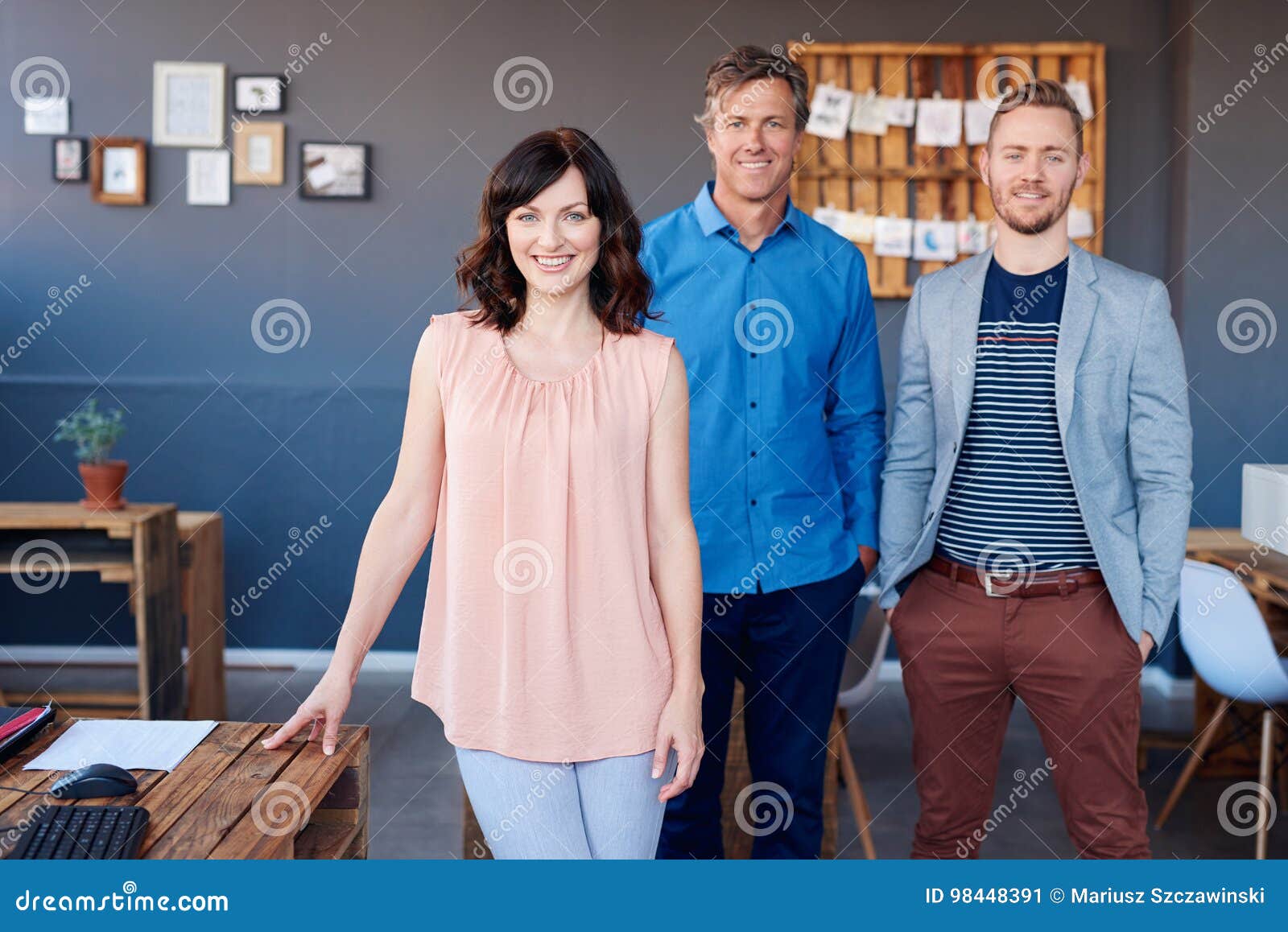 Smiling Work Colleagues Standing Together in a Modern Office Stock ...