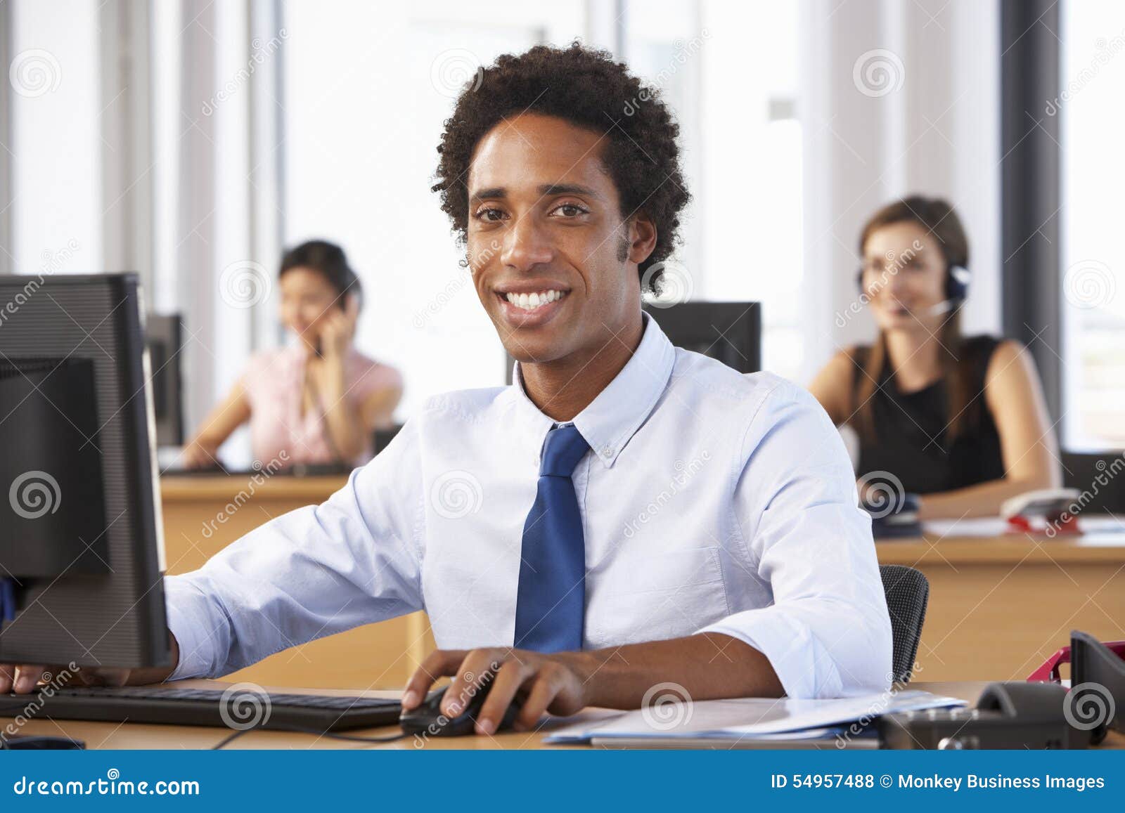 Smiling Worker in Busy Office Stock Photo - Image of businessman ...