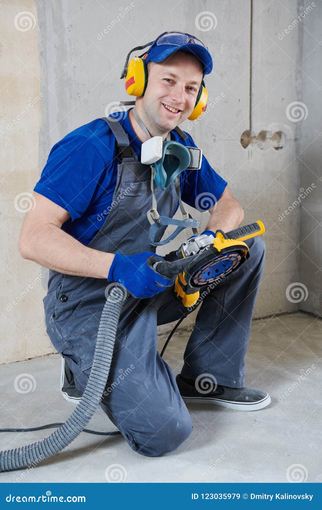 Smiling Worker at Concrete Floor Surface Grinding by Angle Grinder ...