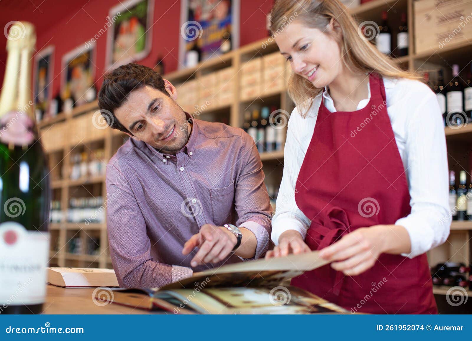 Smiling Worker Giving Advice in Wine Store To Customer Stock Photo ...