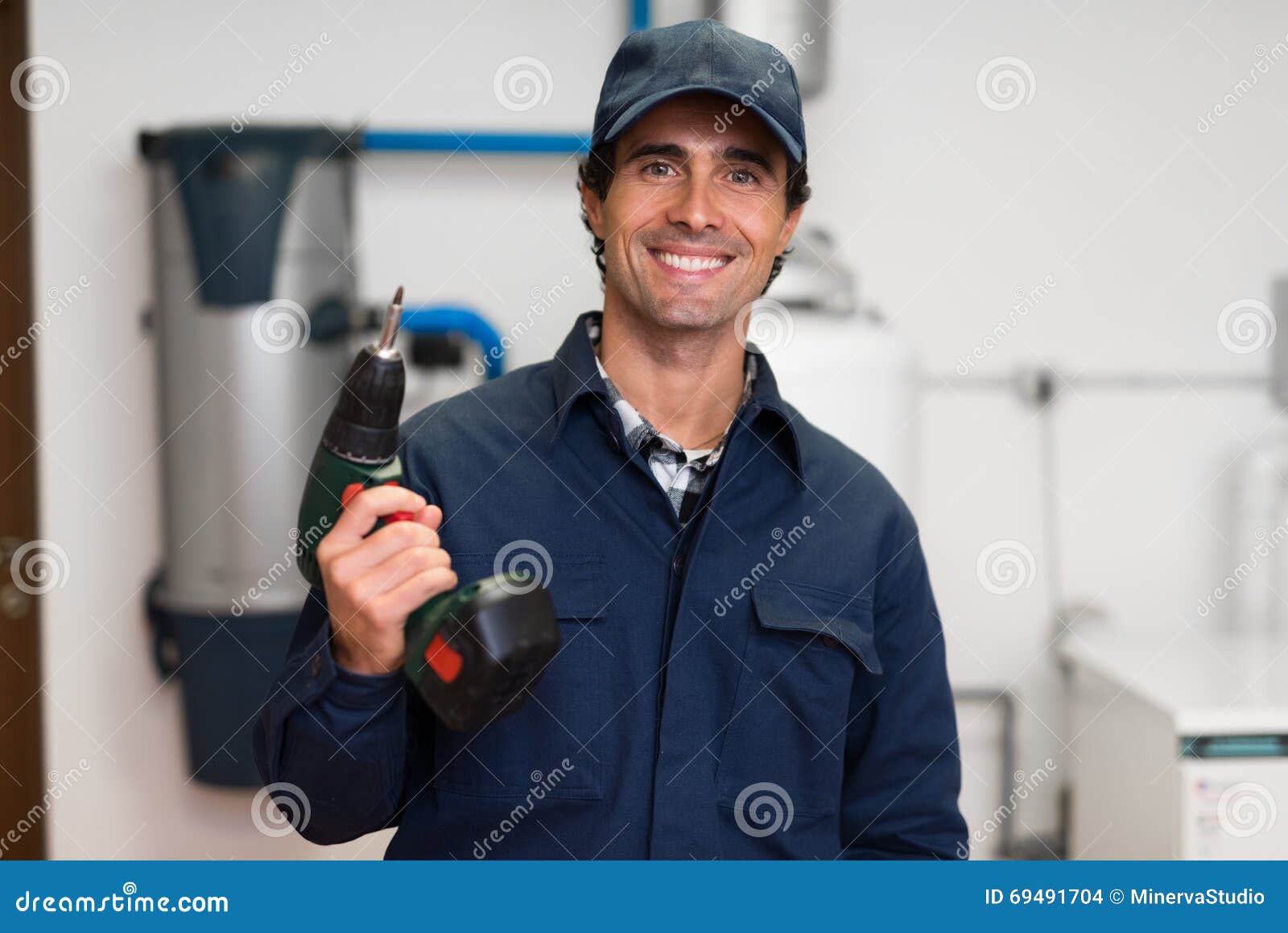 Smiling Worker Holding a Screwdriver Stock Photo - Image of room ...