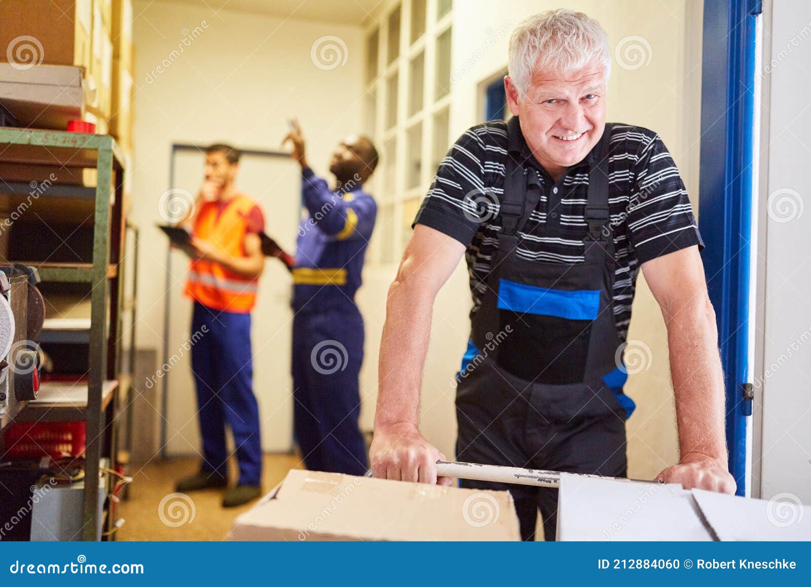 Smiling Worker in Warehouse with Packages Stock Photo - Image of ...