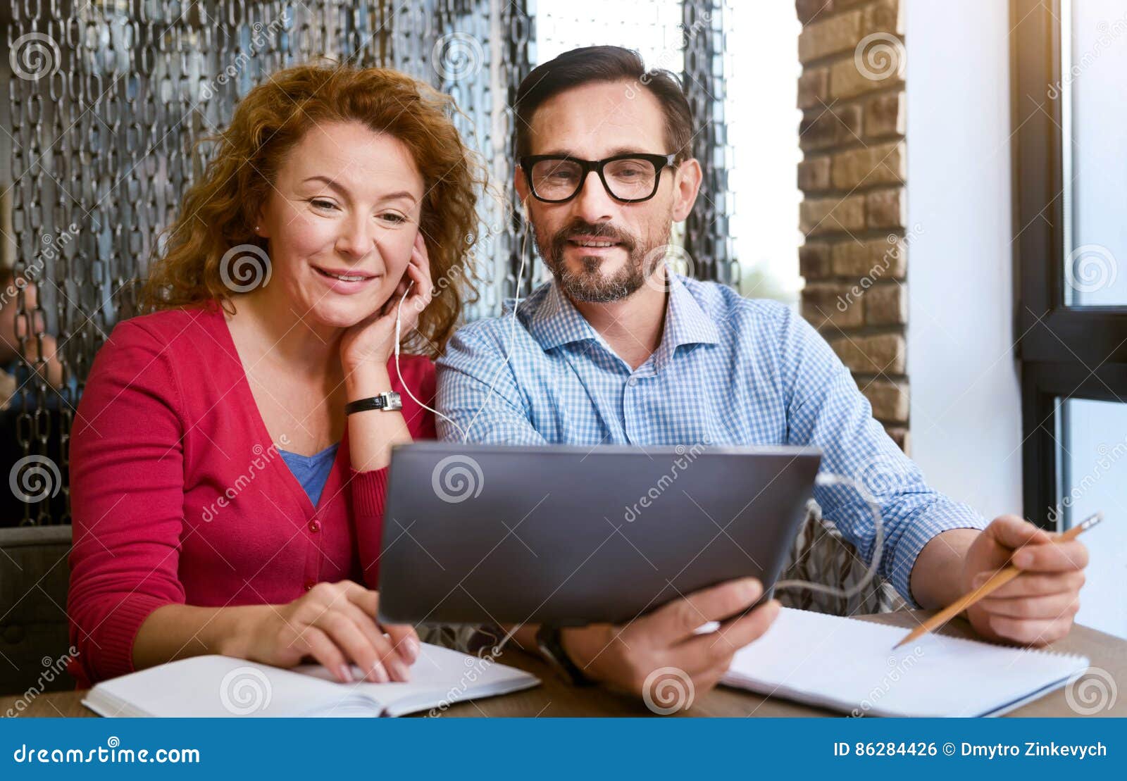 Smiling Workmates Using Modern Gadget In The Cafe Royalty-Free Stock ...