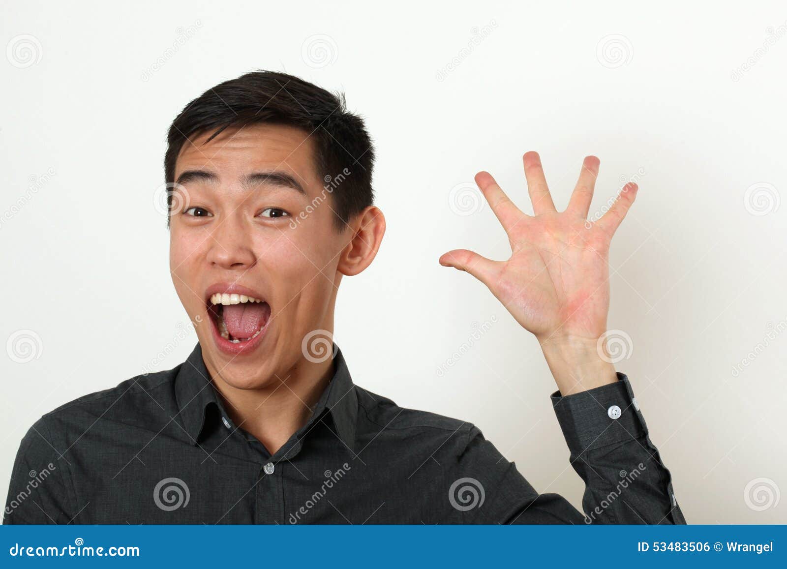 Smiling Young Asian Man Waving His Palm and Looking at Camera Stock ...