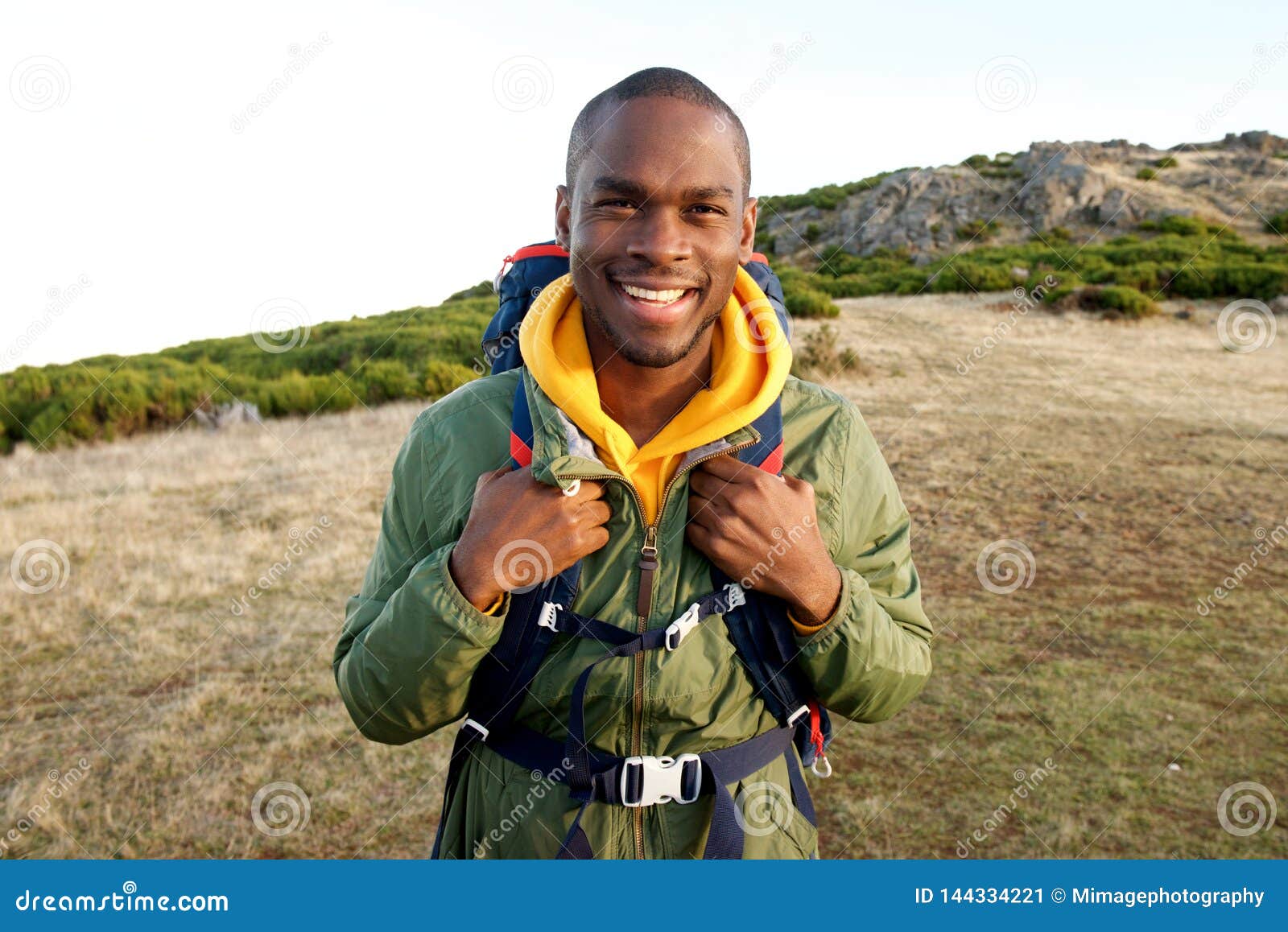 Smiling Young Black Man with Backpack Standing in Nature Stock Image ...