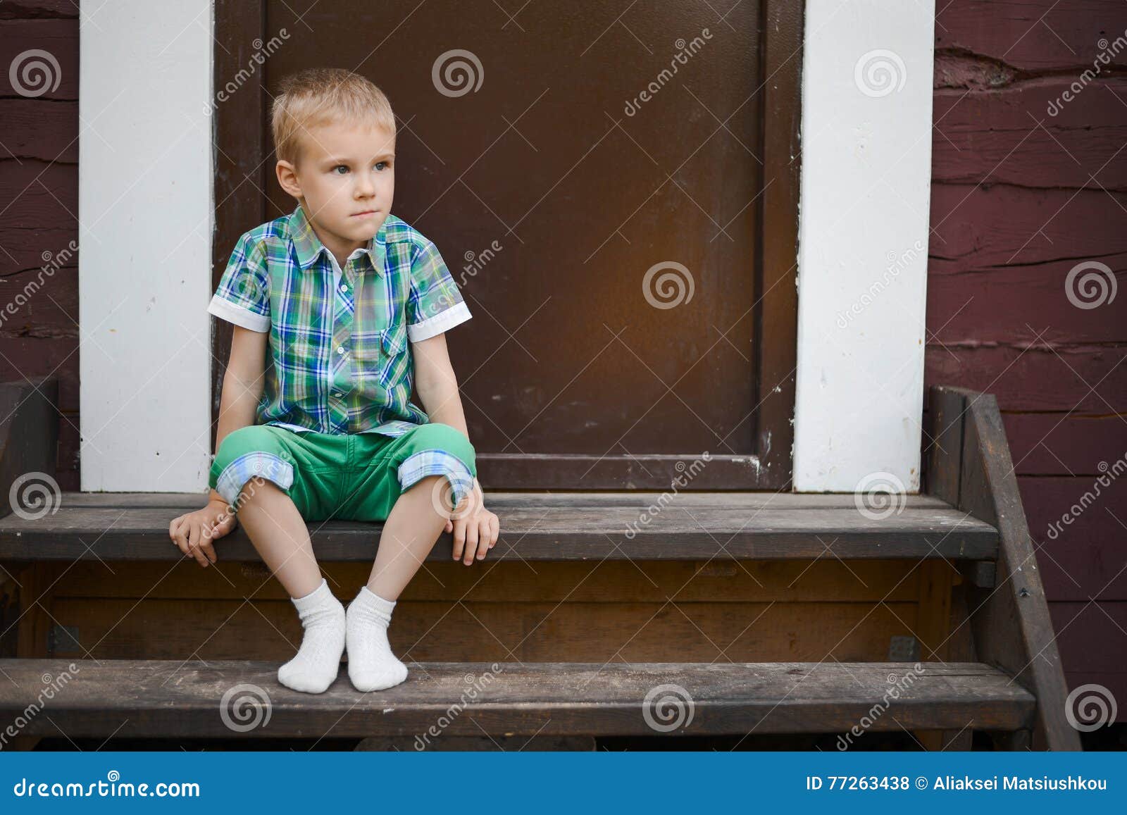Smiling Young Blond Boy Sitting on Porch Steps at Home Stock Photo ...