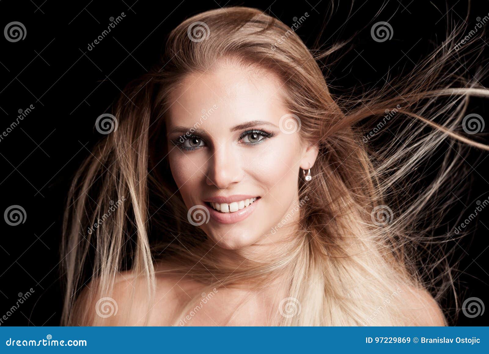 Smiling Young Blonde Woman With Long Healthy Hair In Motion Stock Image