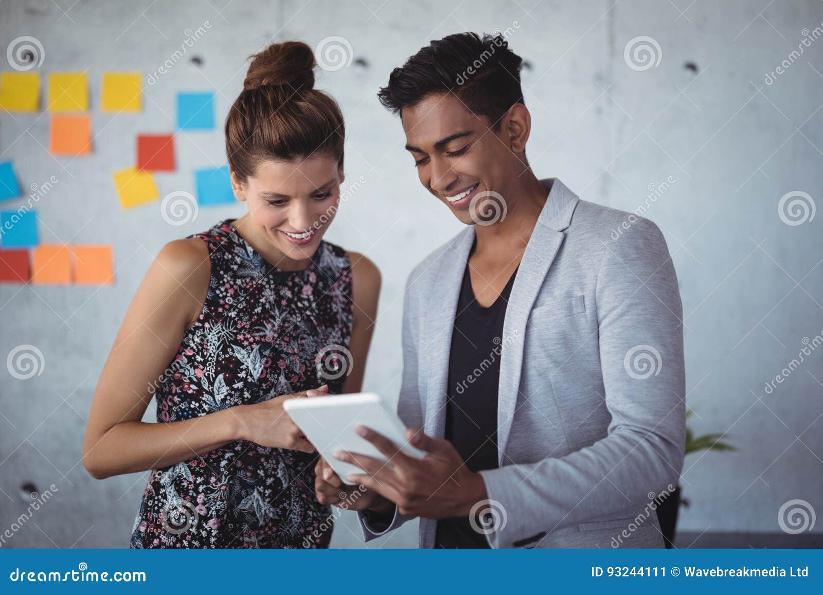 Smiling Young Business Colleagues Working Together on Digital Tablet ... Smiling Young Business Colleagues Working Together on Digital Tablet ...