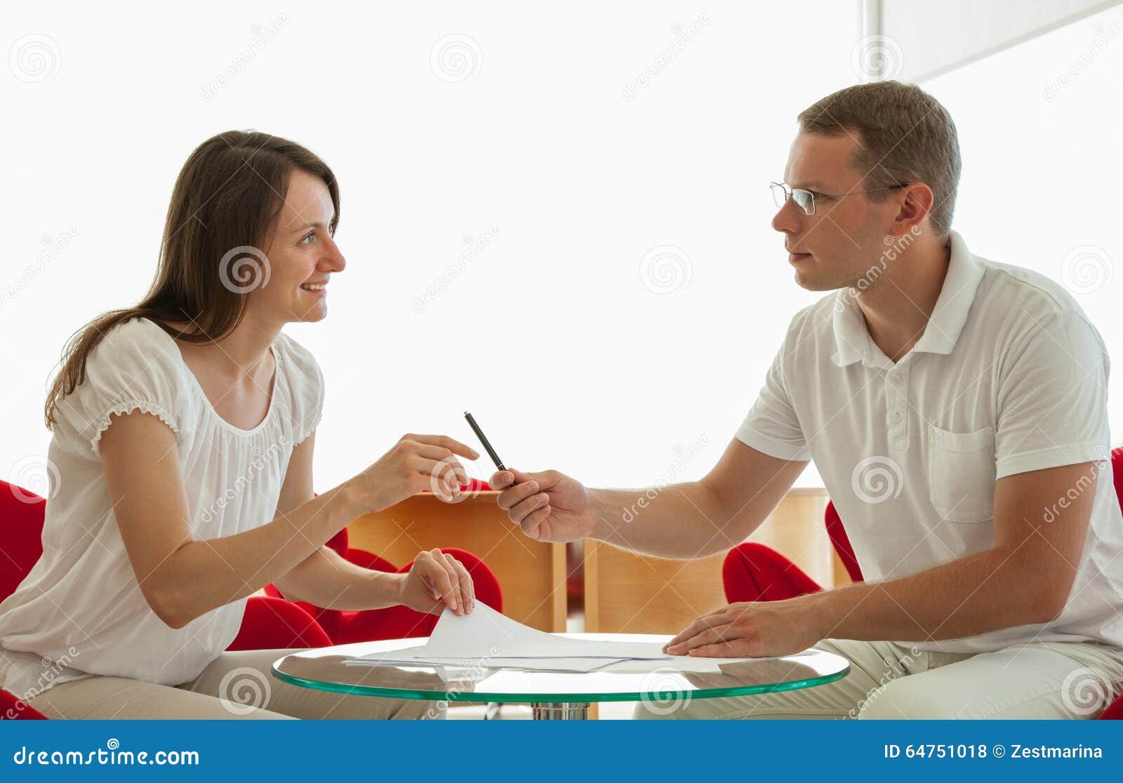 Smiling Young Business People Signing a Contract Stock Photo - Image of ...