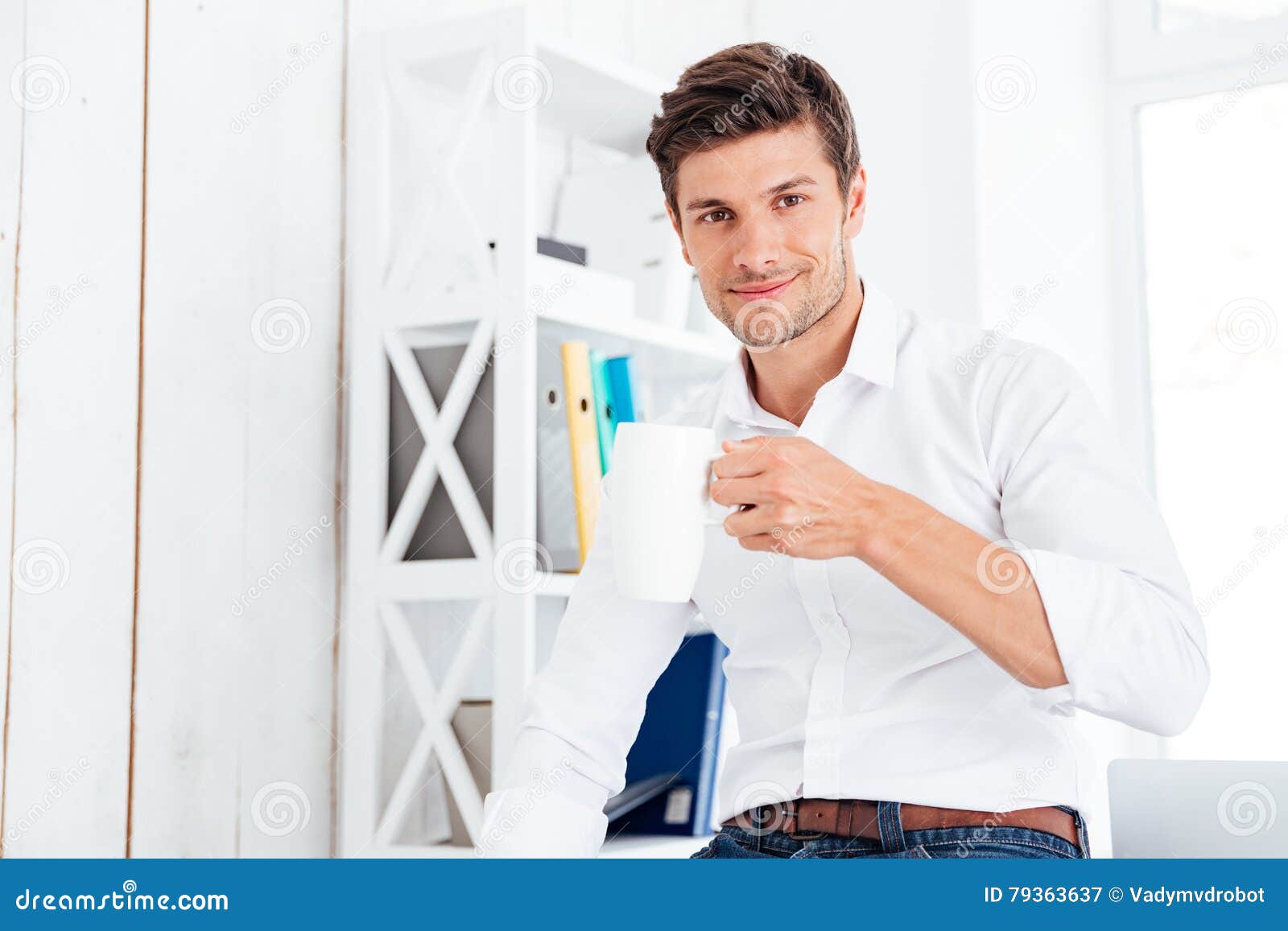 Smiling Young Businessman Drinking Cup of Tea in the Office Stock Image ...