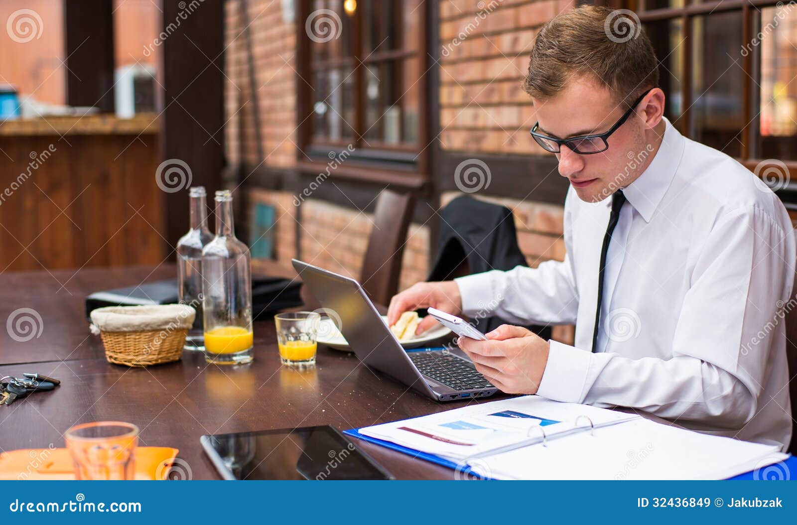 Smiling Young Businessman Making a Call with His Smartphone in a ...