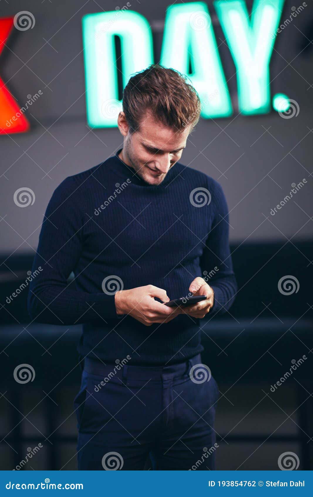Smiling Young Businessman Sending a Text Message at Work Stock Photo ...