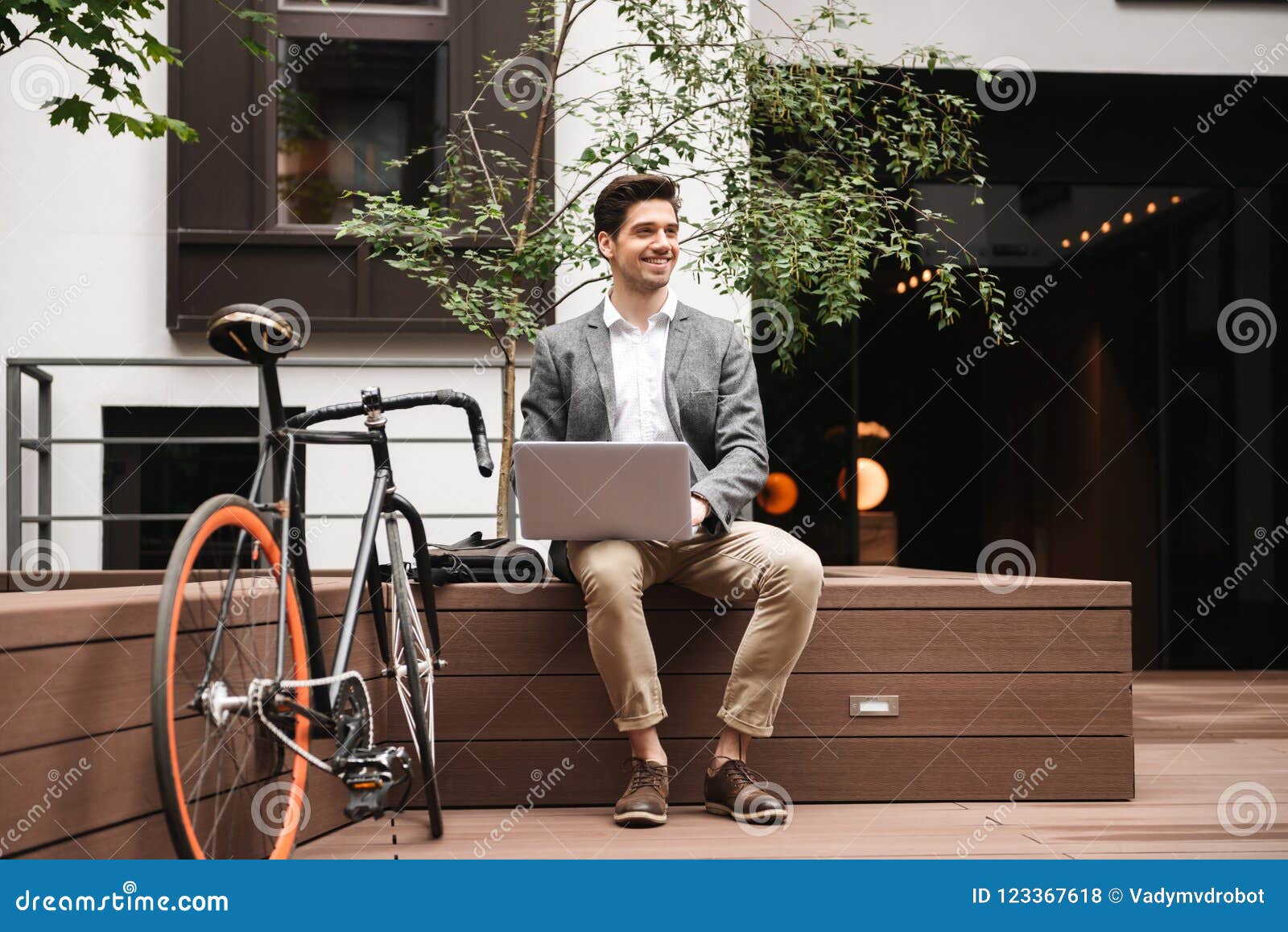 Smiling Young Businessman Using Laptop Computer Stock Photo - Image of ...