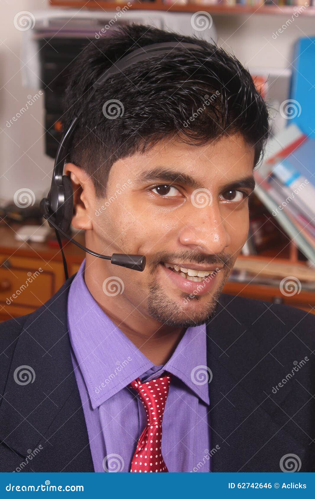 Smiling Young Call Center Executive with Headsets Stock Photo - Image ...