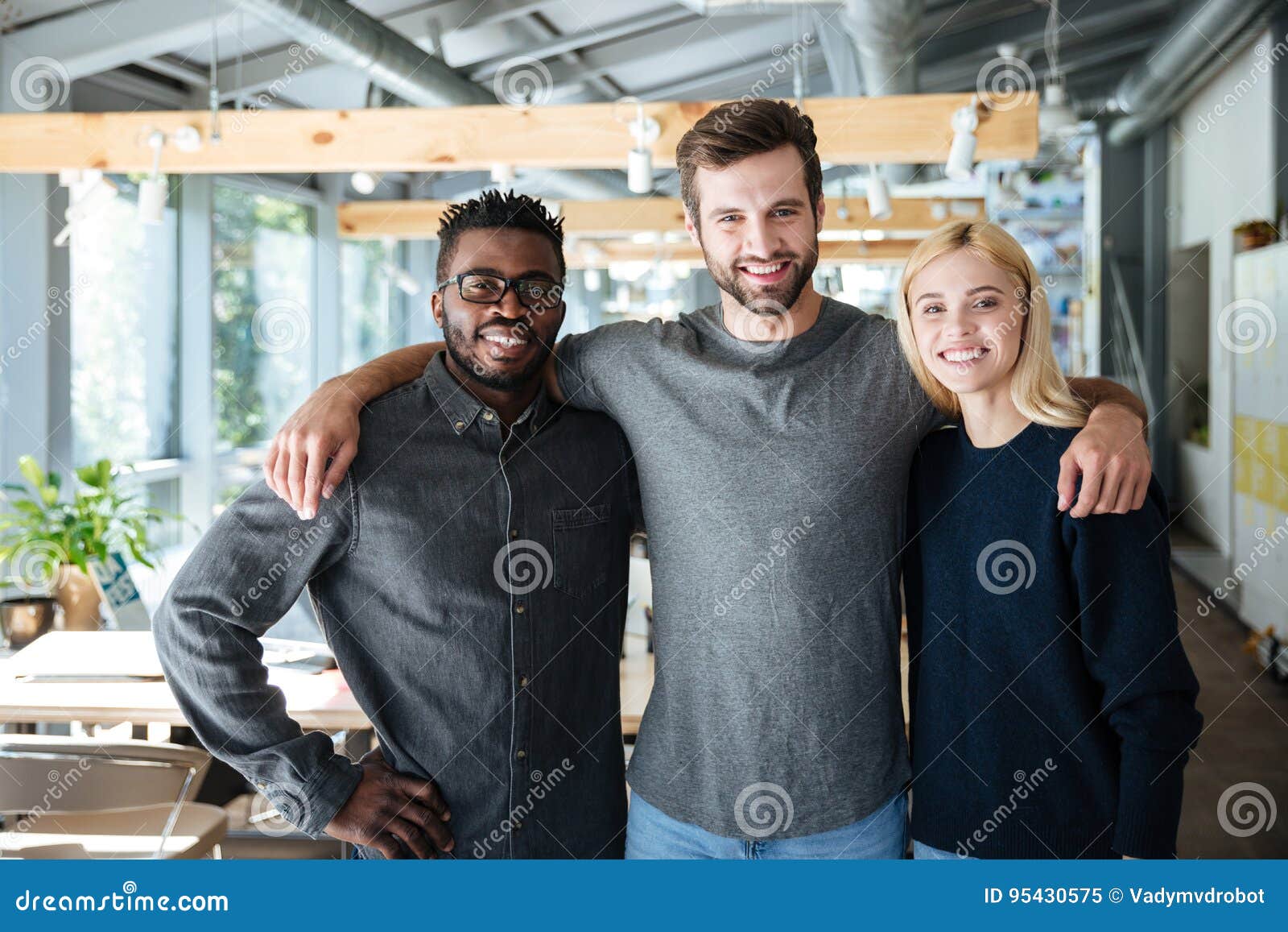 Smiling Young Colleagues Standing in Office. Stock Image - Image of ...