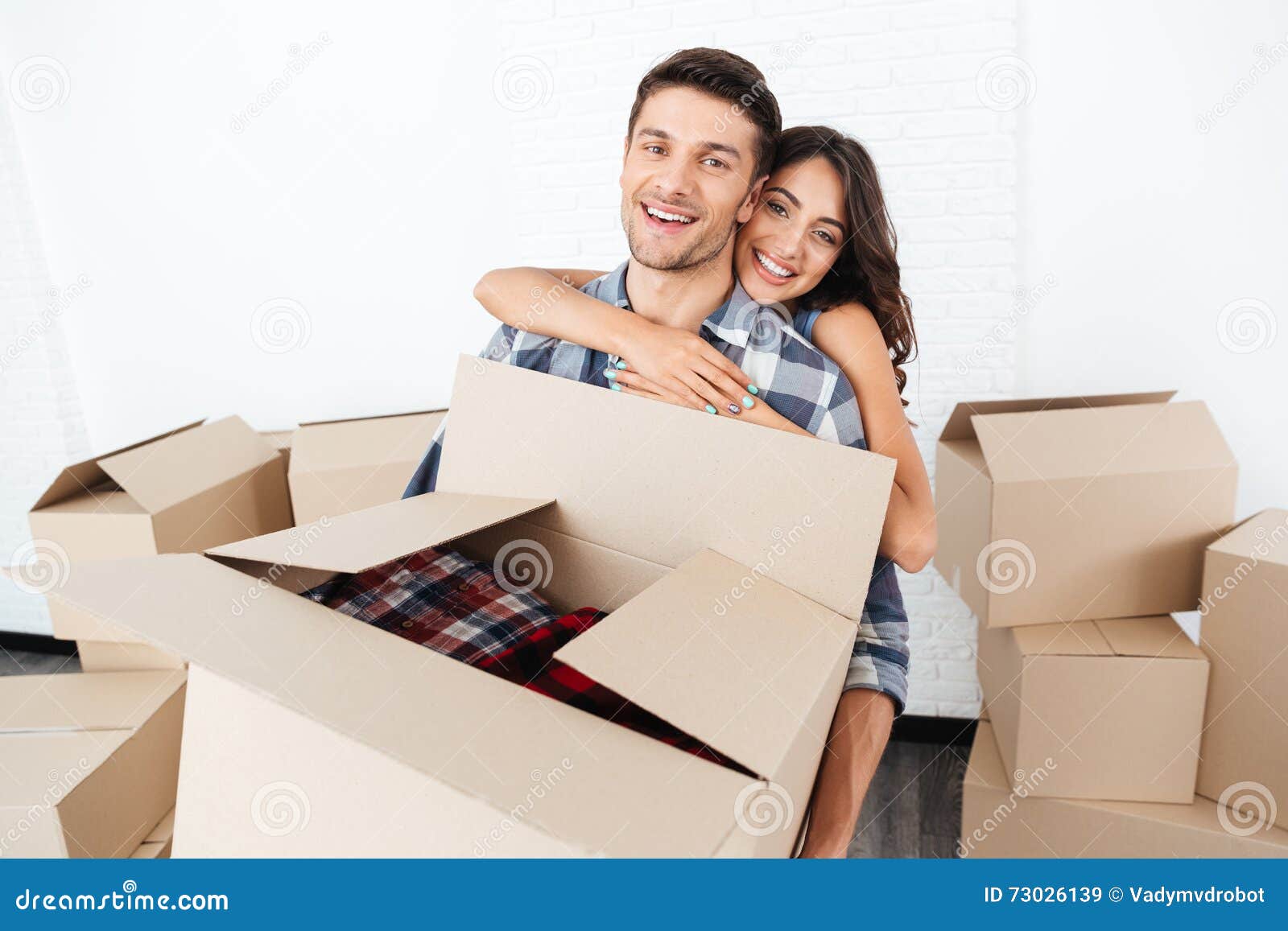 Smiling Young Couple Carrying Cardboard Boxes and Hugging Stock Image ...