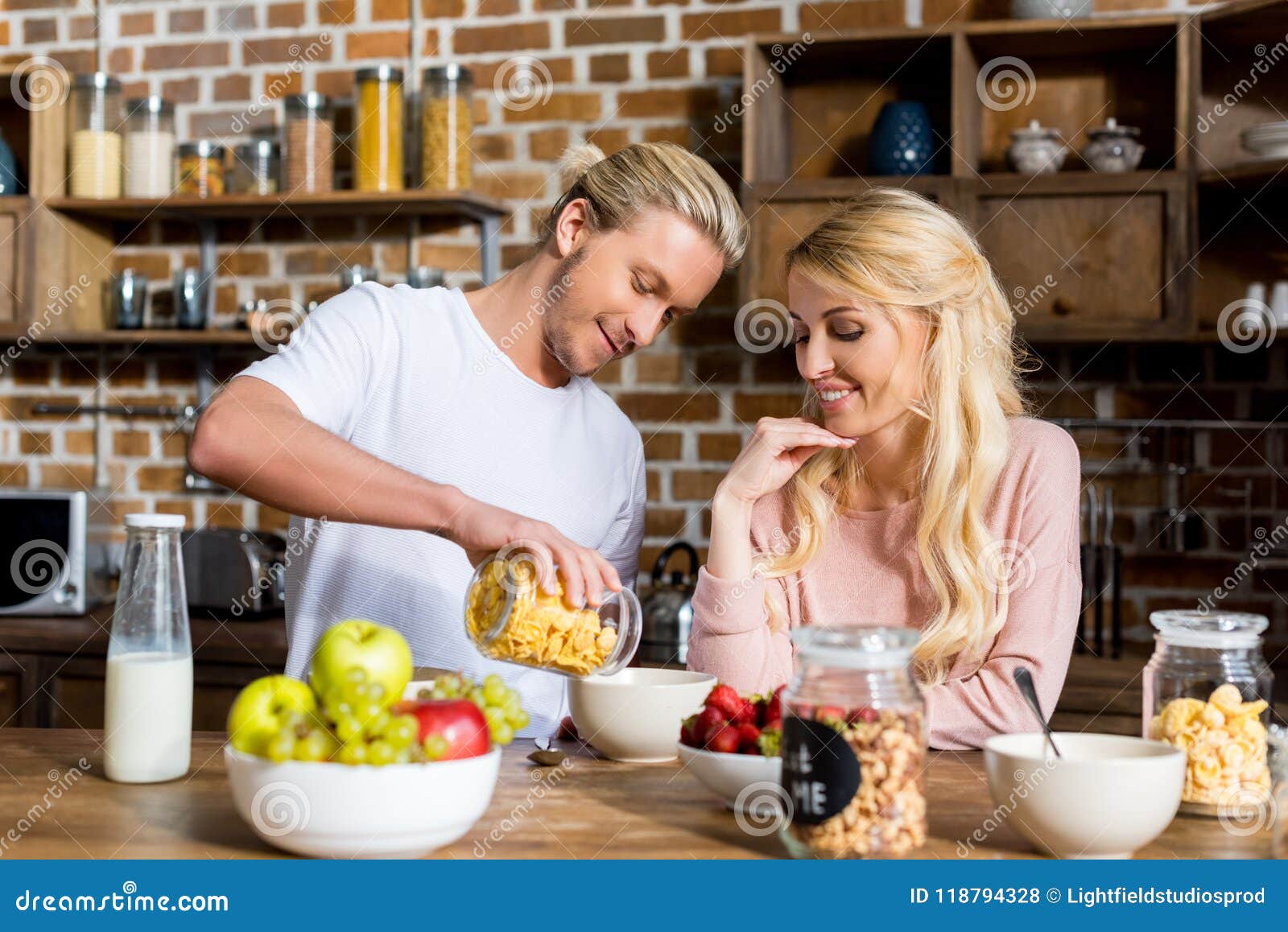 Smiling Young Couple Having Breakfast Together Stock Photo - Image of ...