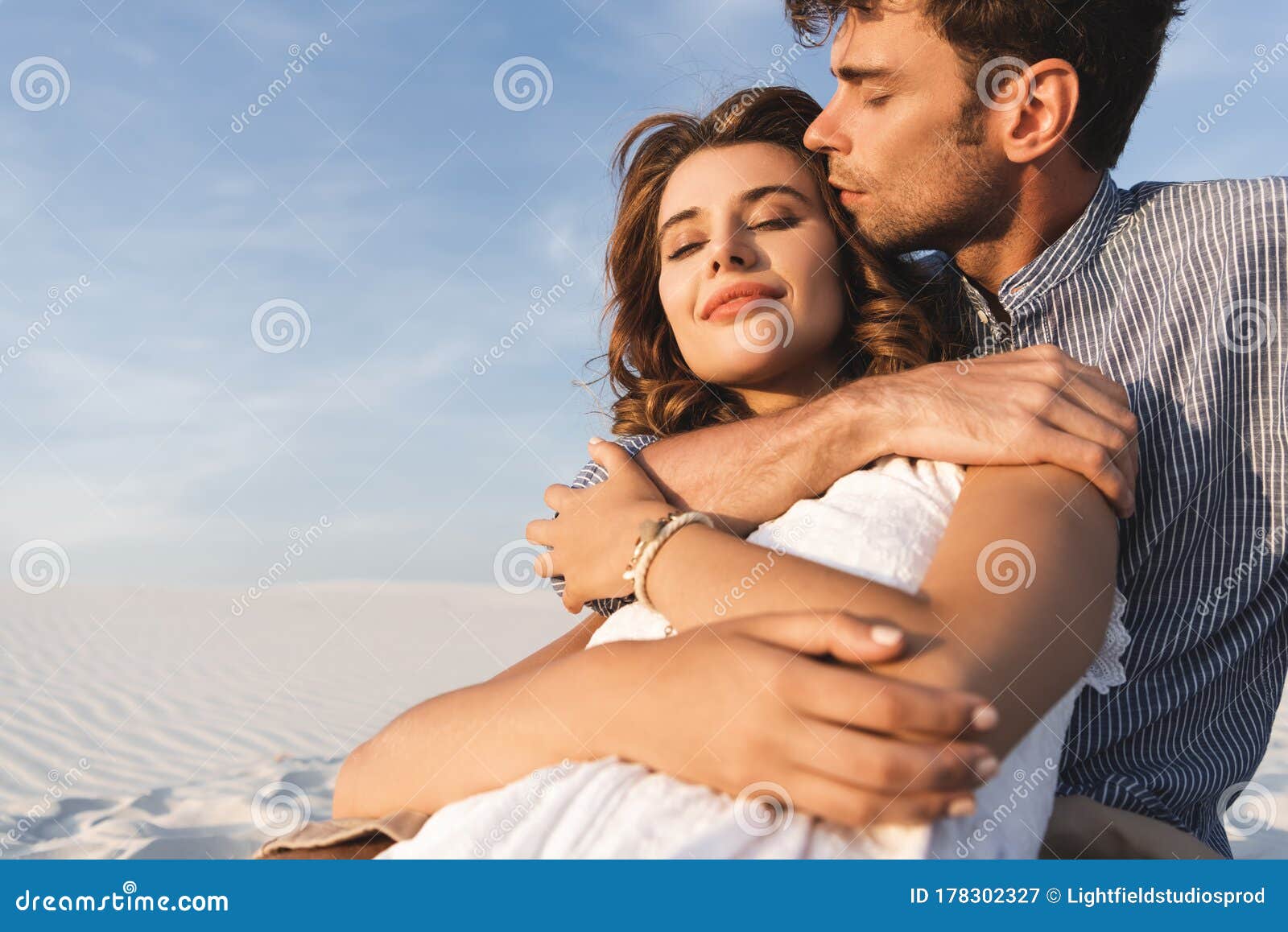 Couple, Hugging Each Other, Lie In Bed With A Laptop Stock Photo ...