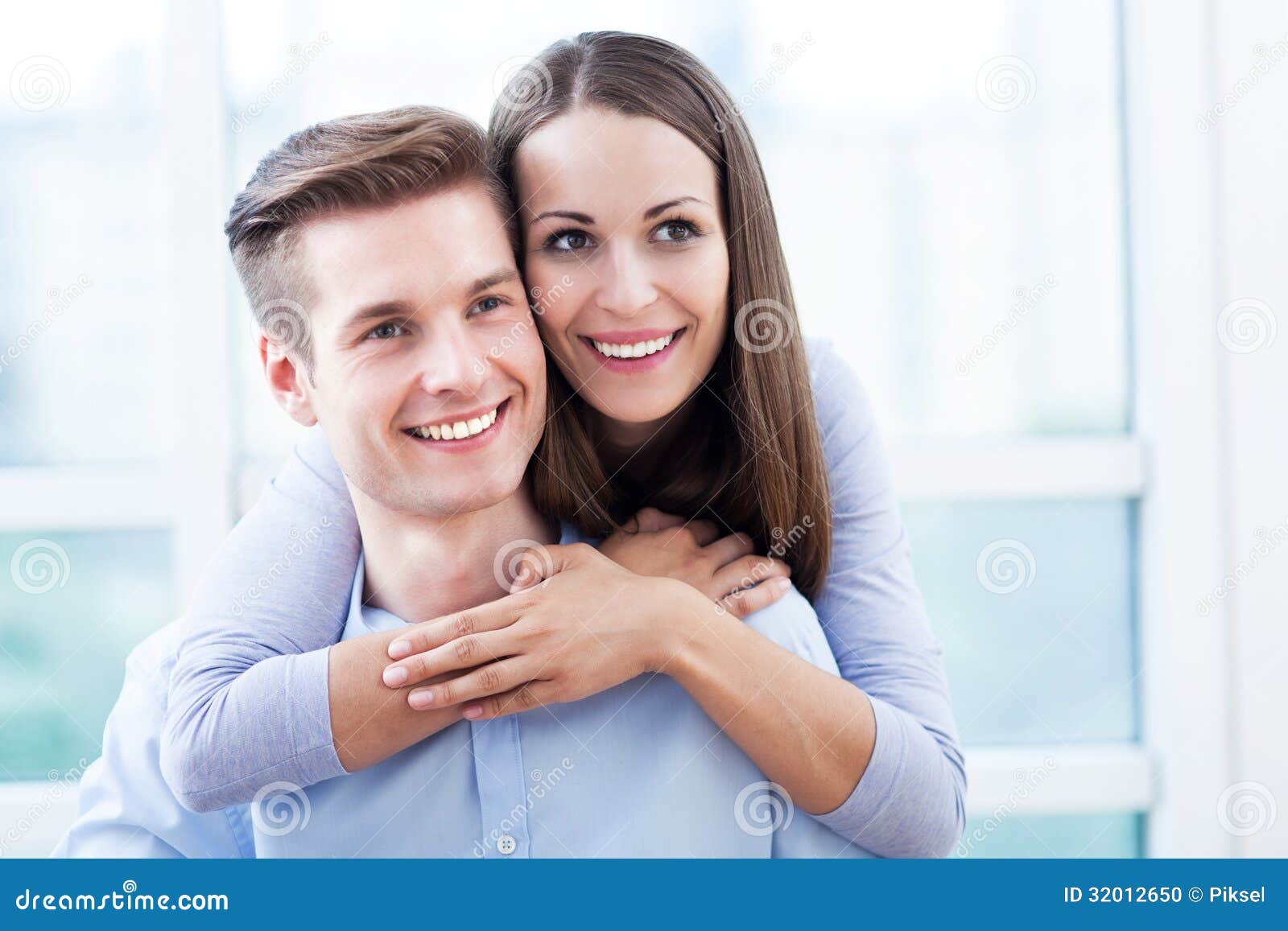 Smiling Young Couple Hugging Stock Photo - Image of caucasian, carefree ...