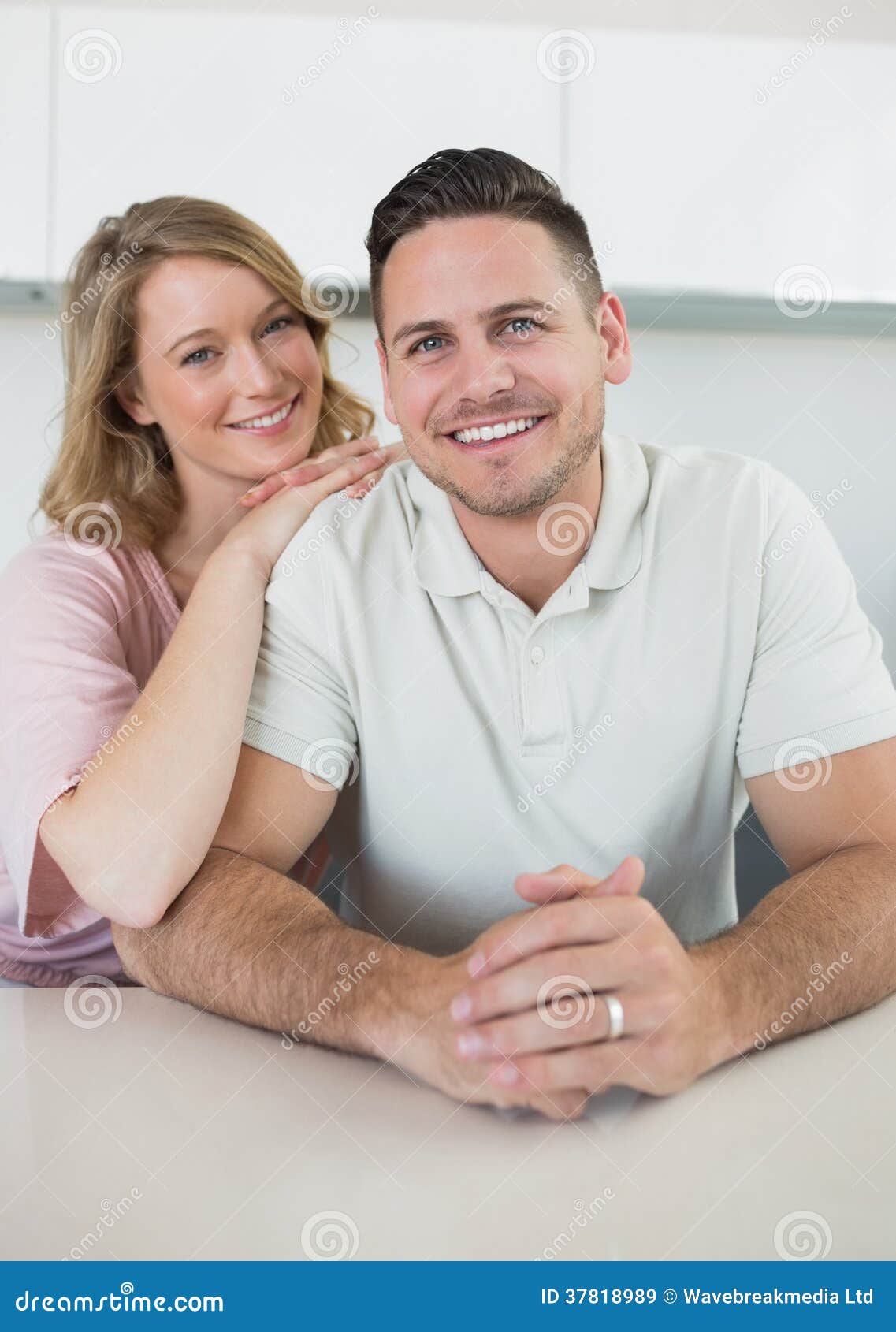 Smiling Young Couple at Kitchen Counter Stock Image - Image of portrait ...