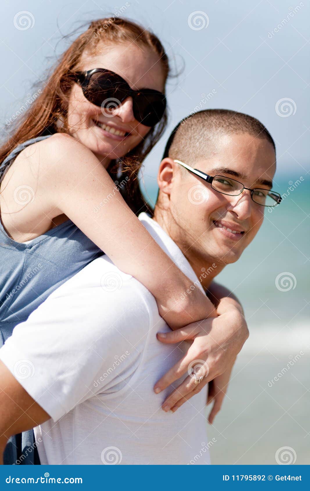 Smiling Young Couple Piggybacking Stock Photo - Image of lifestyle ...