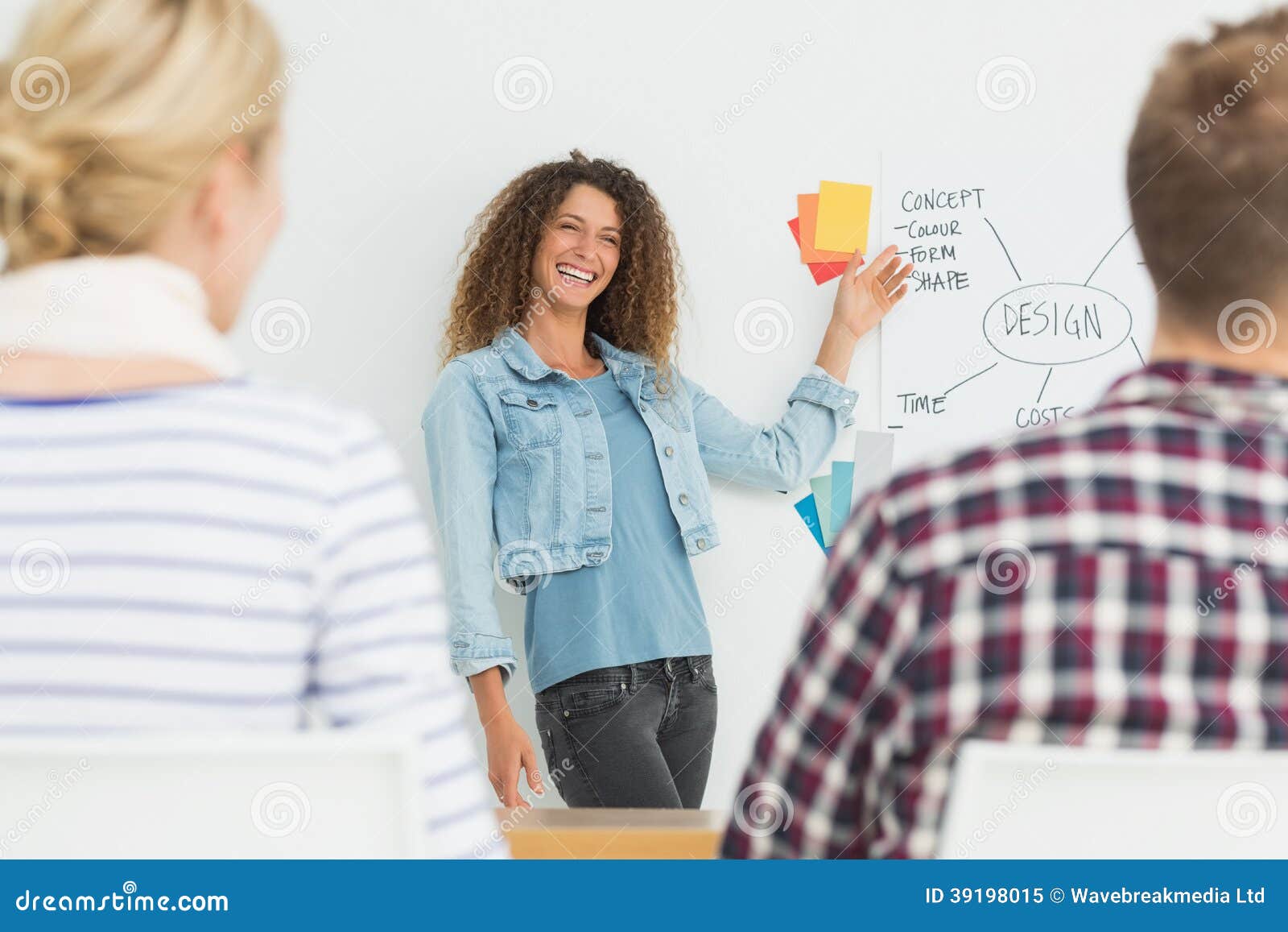 Smiling Young Designer Presenting Ideas To Her Colleagues Stock Image ...